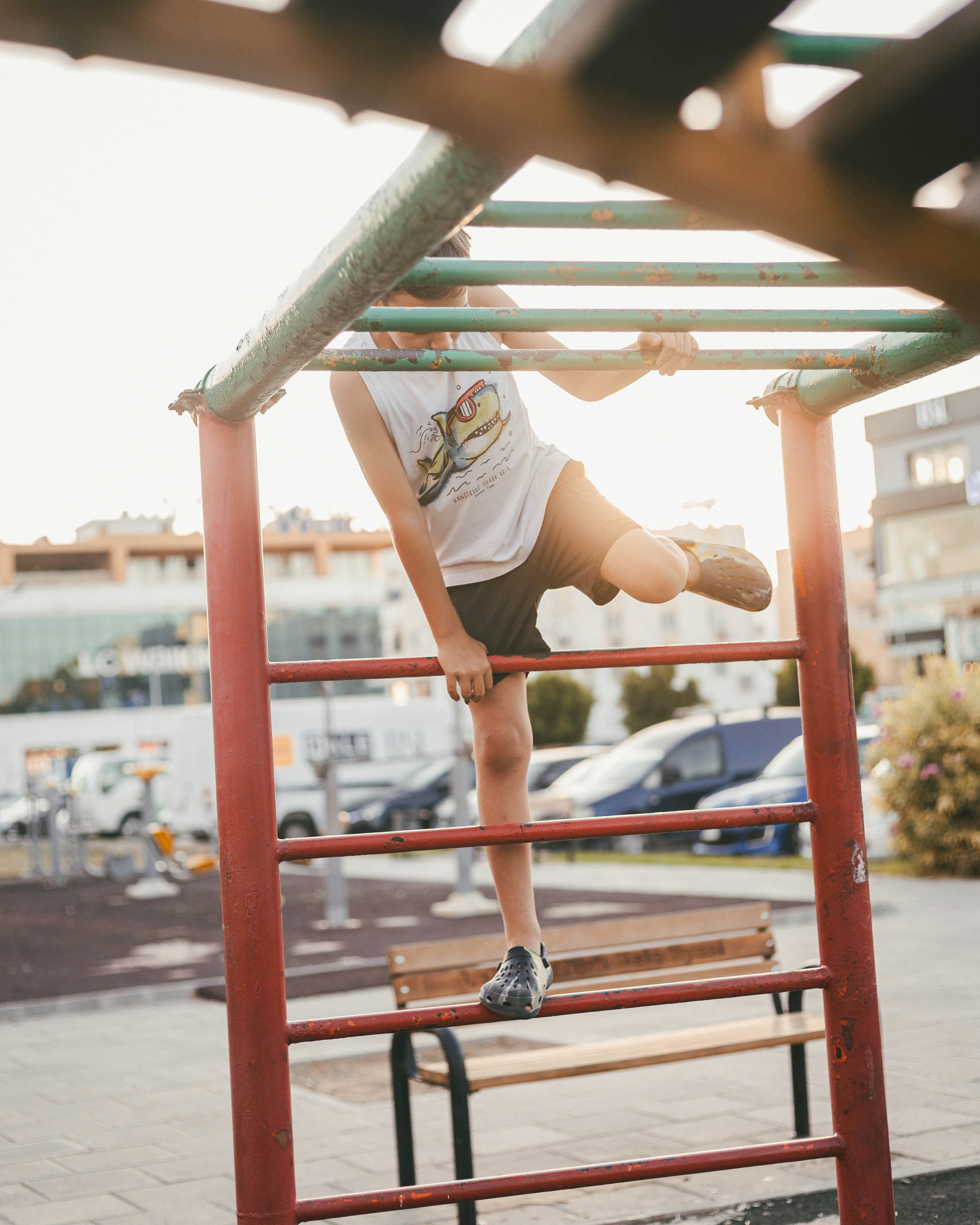 Climber's Pause: A Moment on Red Bars Under Soft Afternoon Light