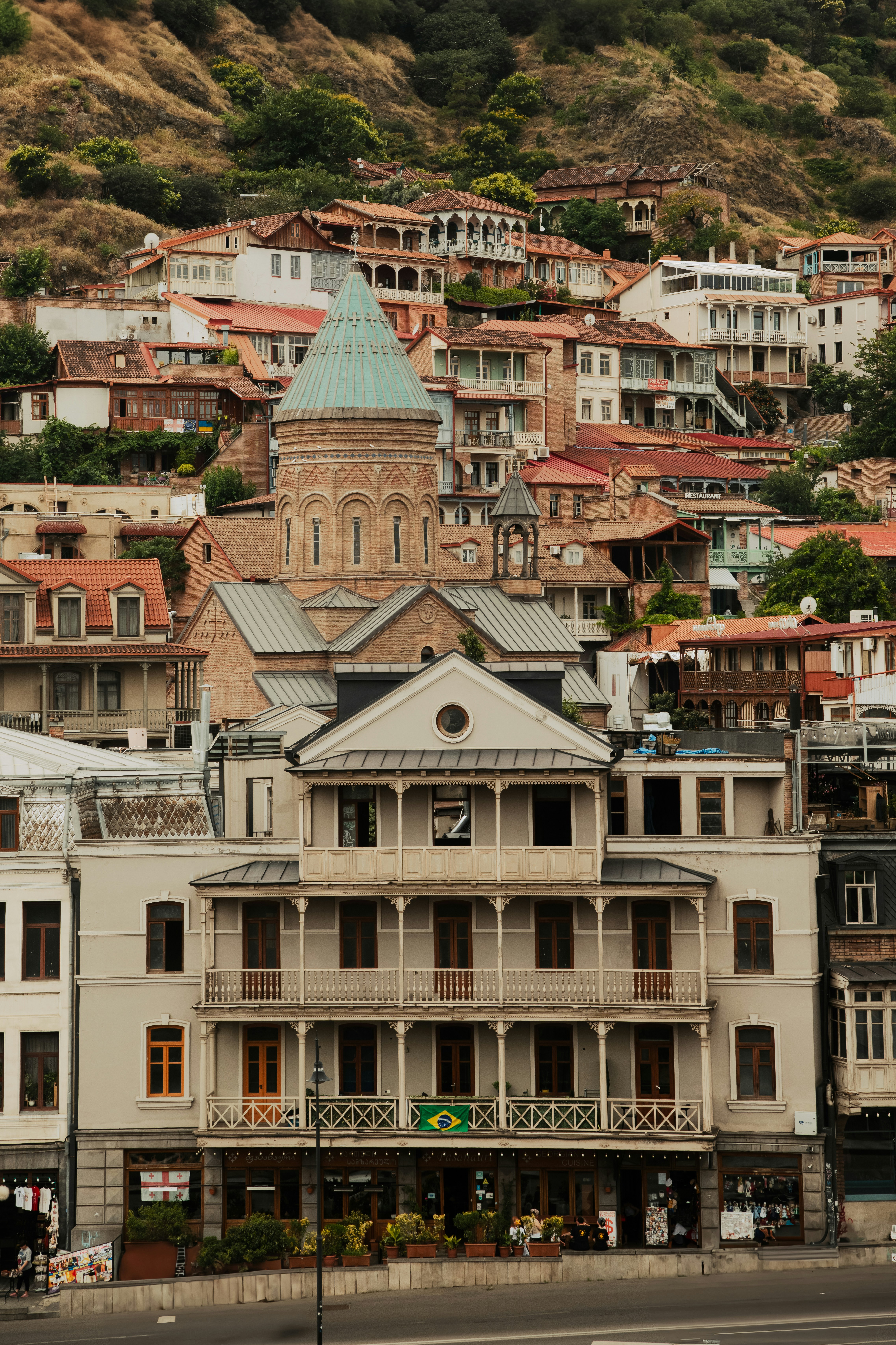 Stone Facades and Terraced Rooftops: A Georgian-Influenced Cityscape Clinging to the Hill