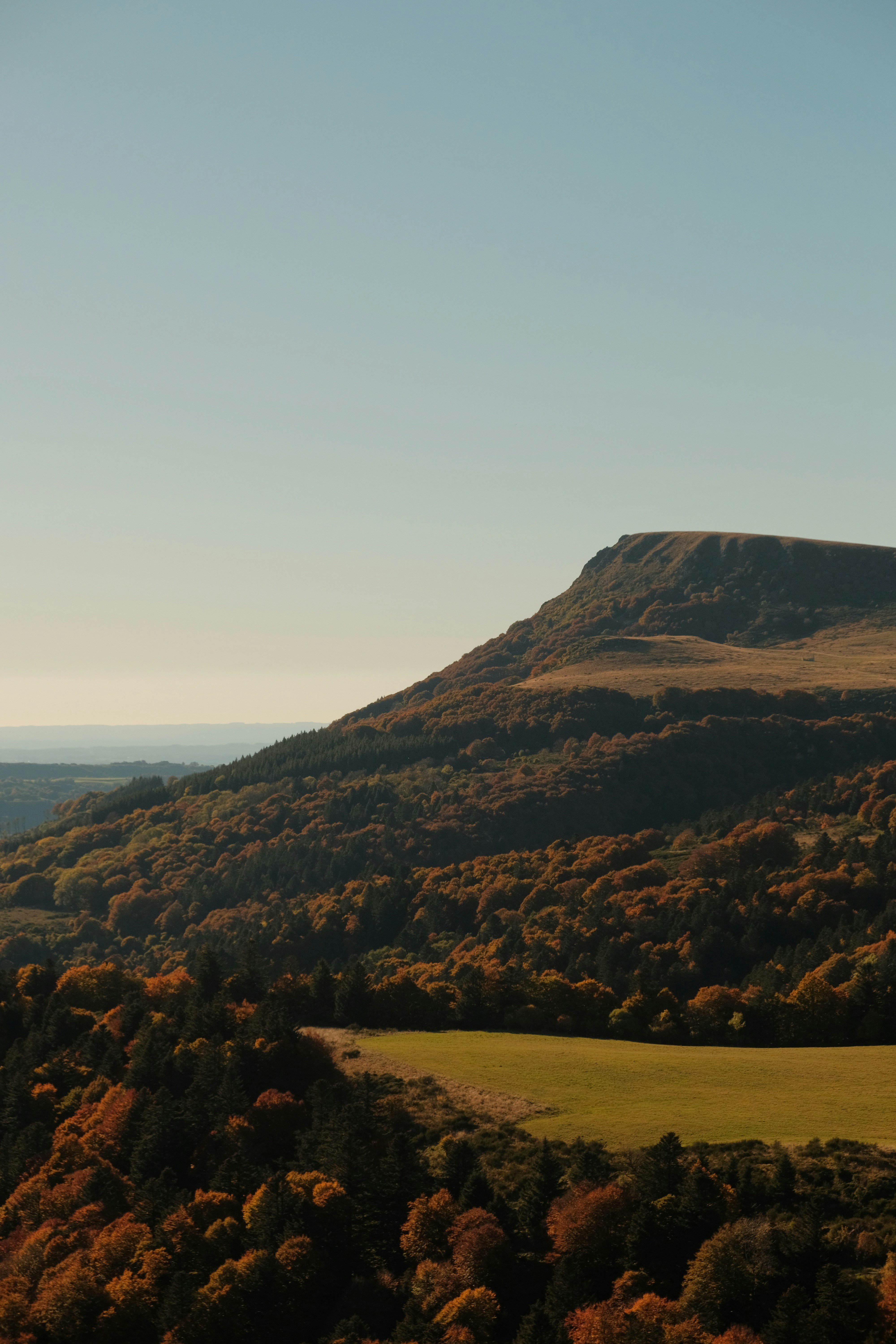 Sunlit Crest: A Plateau Crowned by Autumn Hills