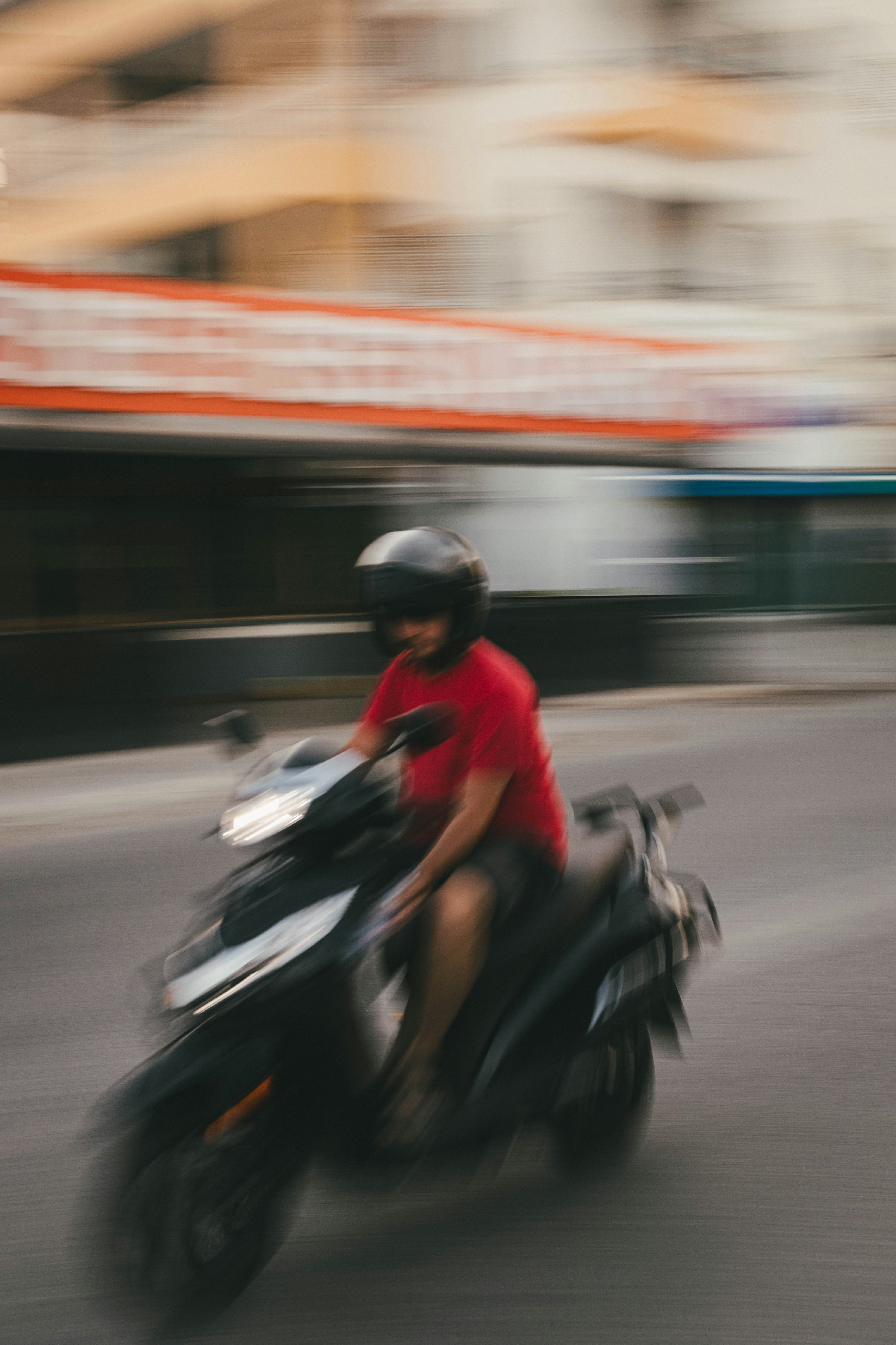 Blurry Rider in Red: Motion Through a City Fade