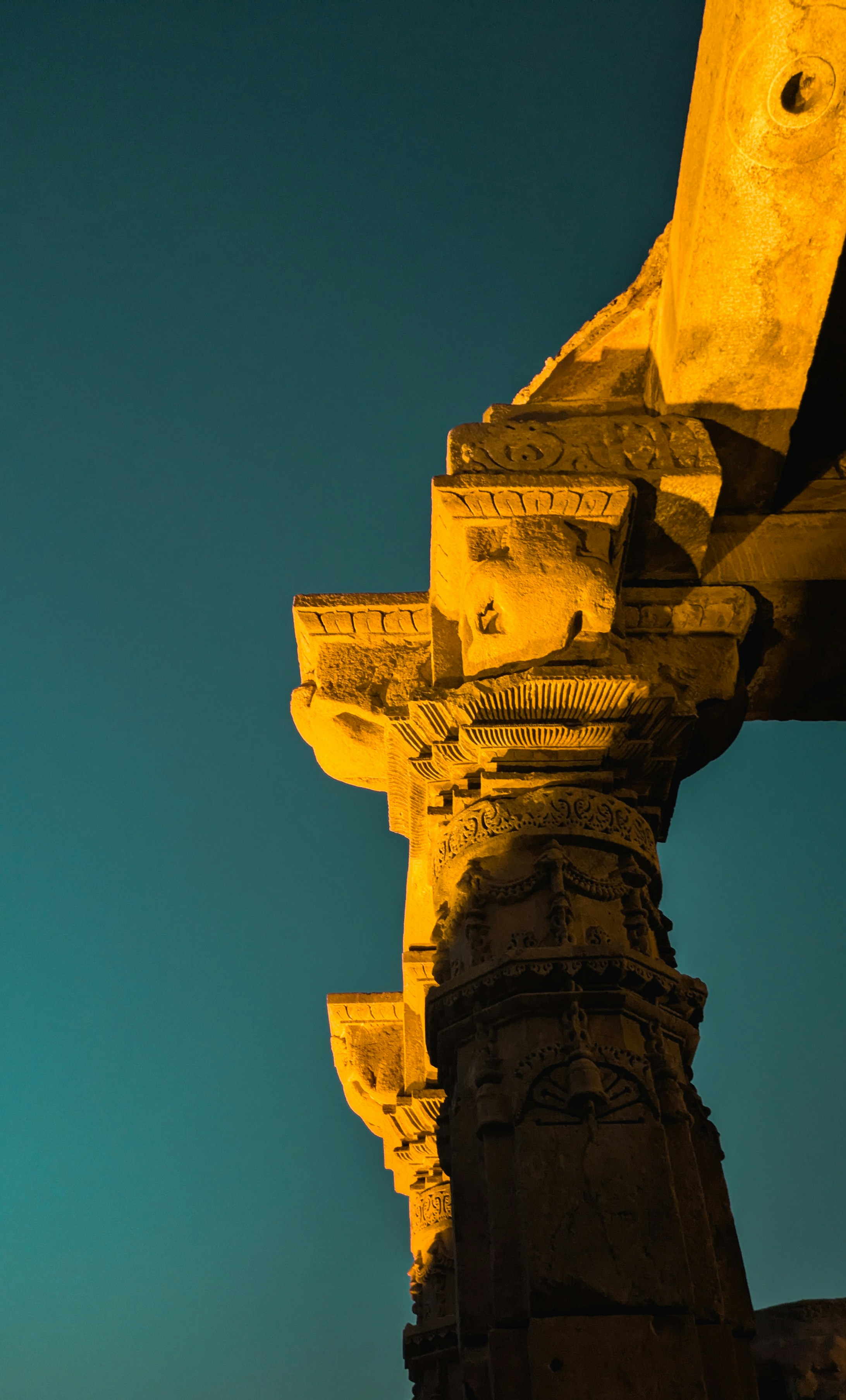 Golden Pillar in Twilight: Ancient Carved Colonnade Reaching Skyward