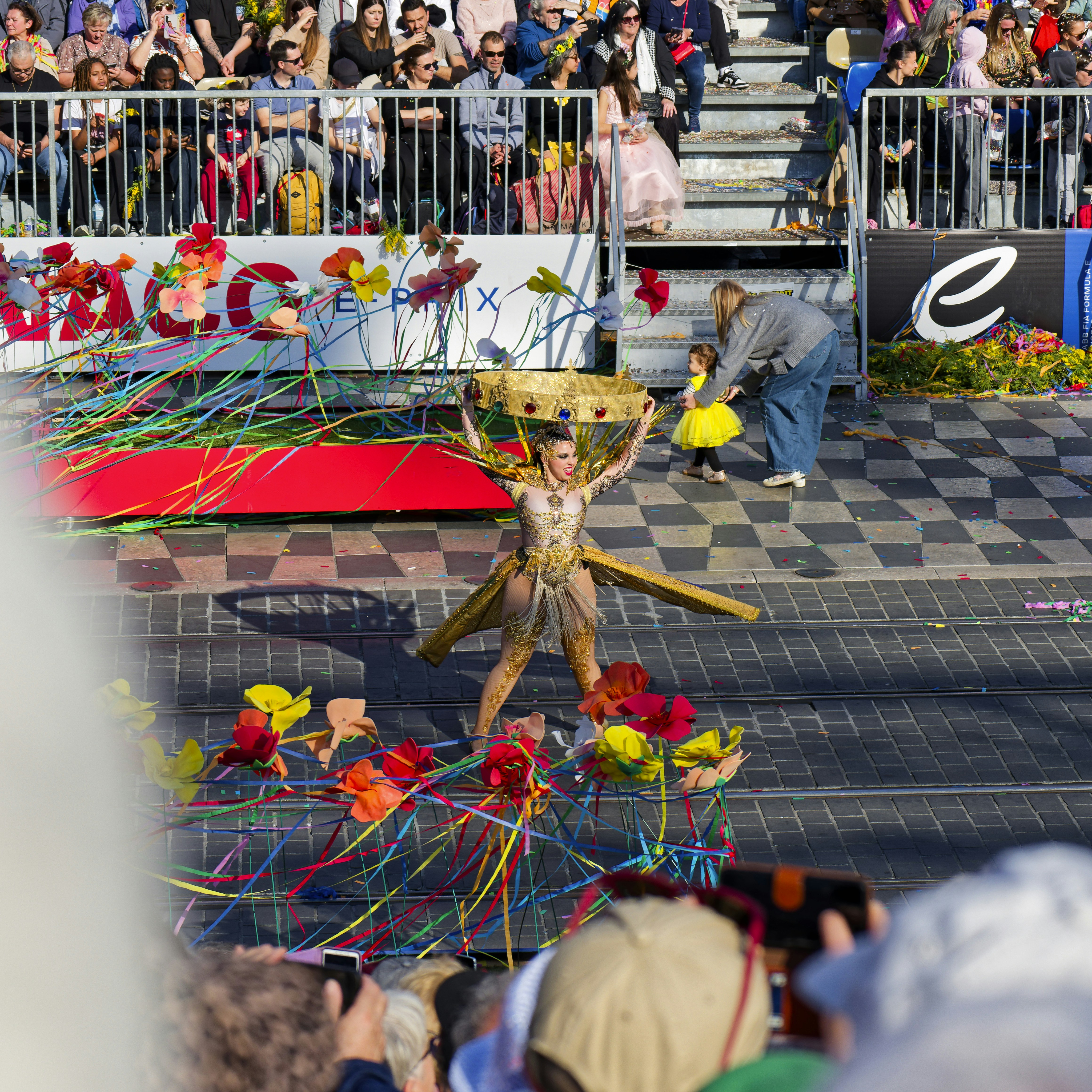 Cross-Stage Acrobat with Rainbow Streamers in a Carnival Parade