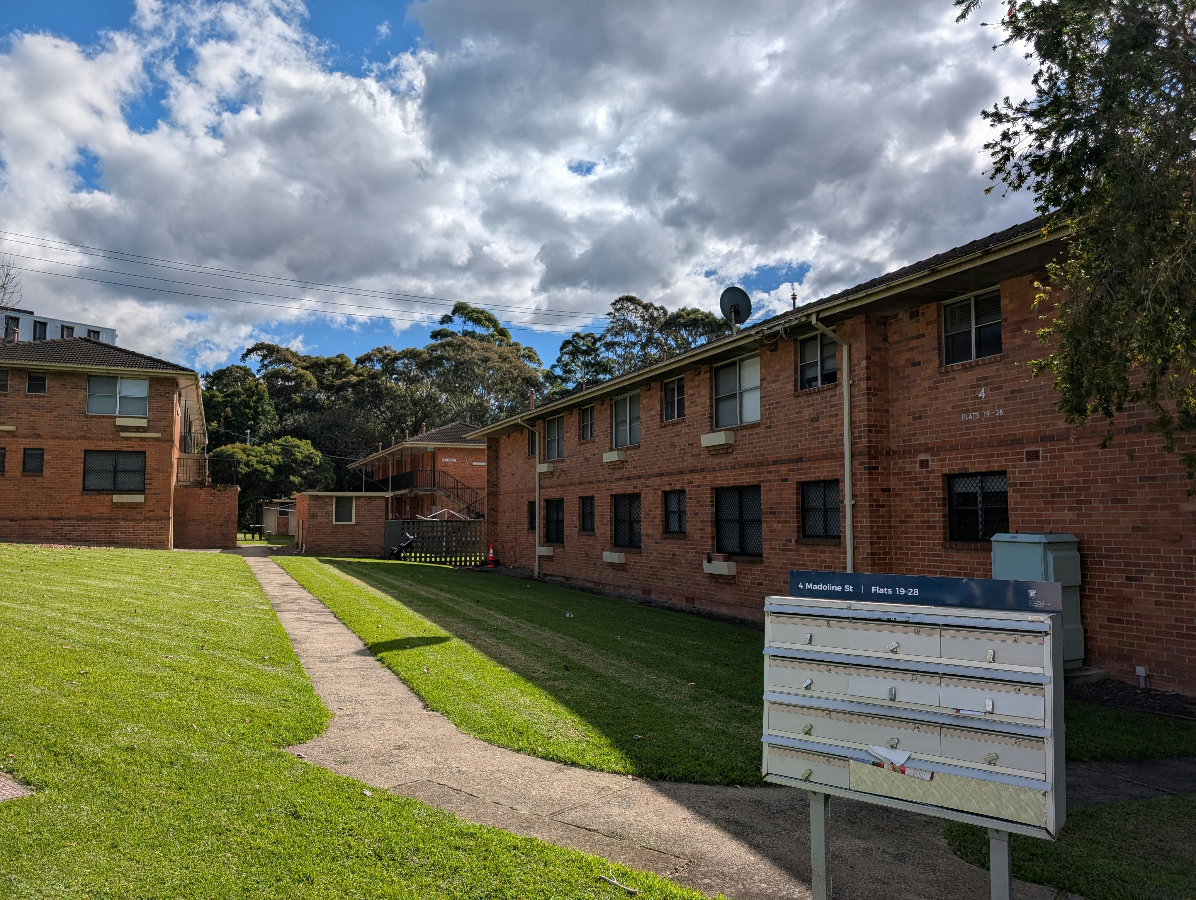 Brick-Row Courtyard: Sunlit Path Through a College-Style Housing Block