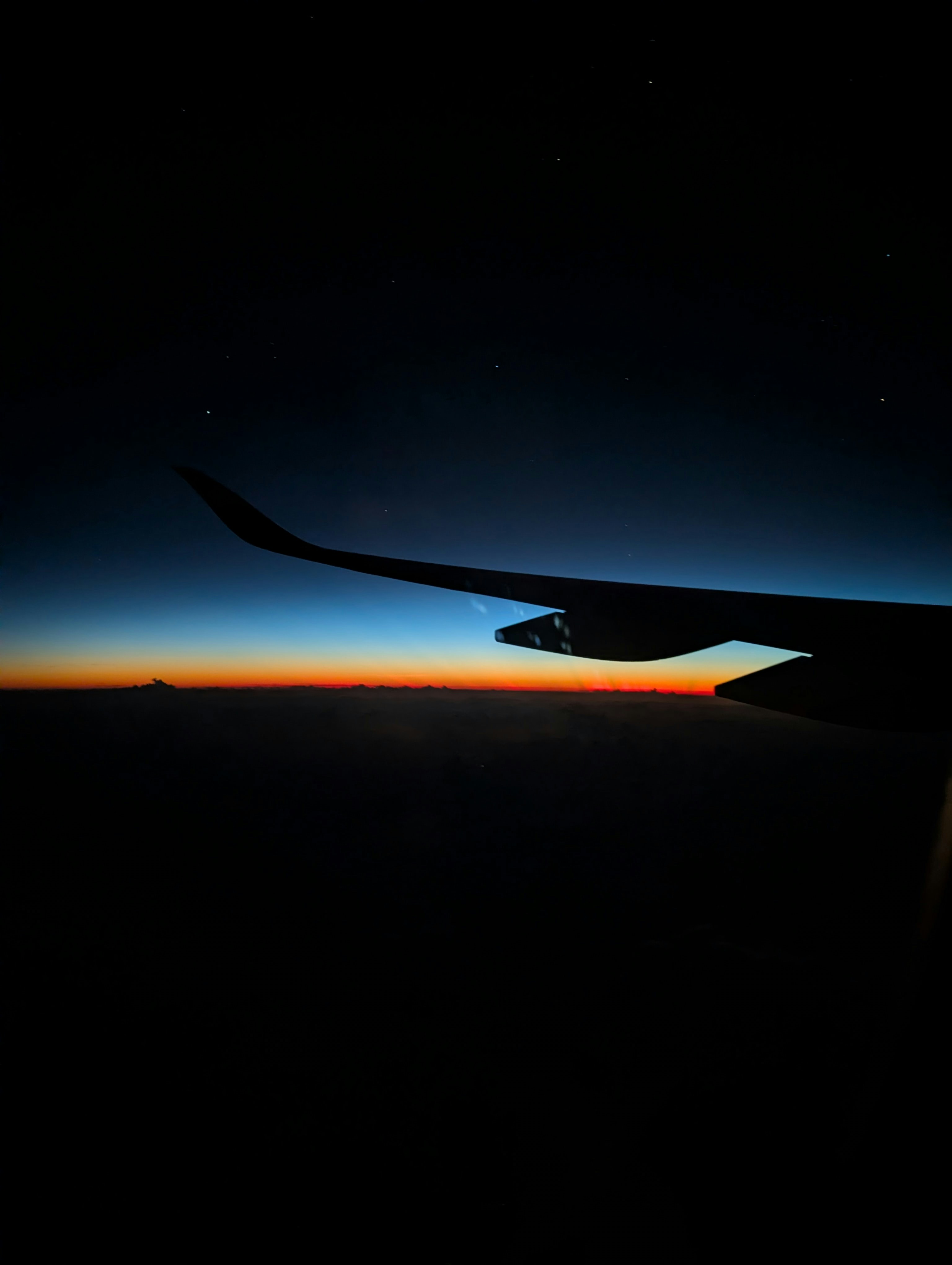 Wingtip Twilight: Sunset Light Traces Across a Quiet Sky