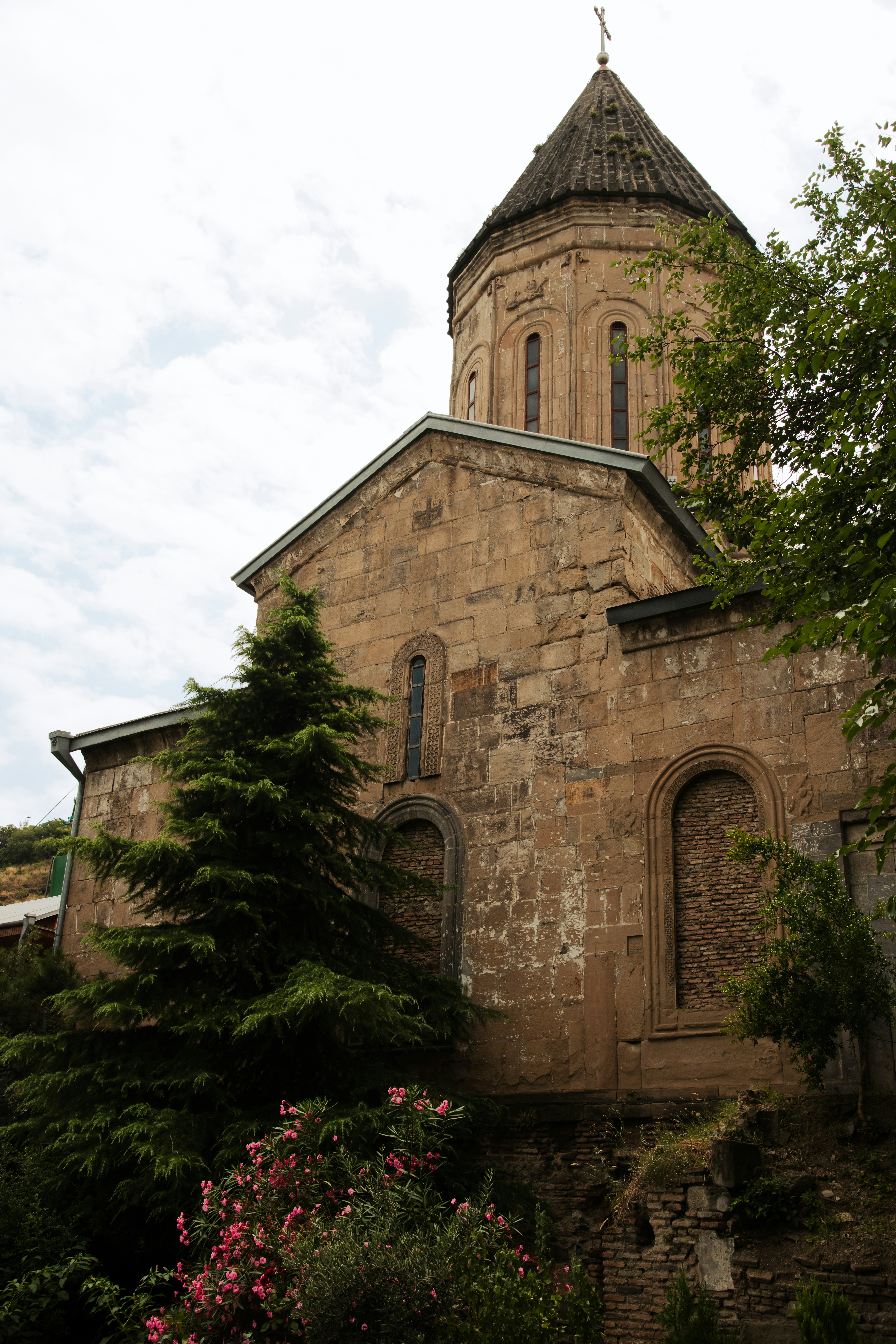 Stone Chapel Rising: A Tower Peeks Through Verdant Frame