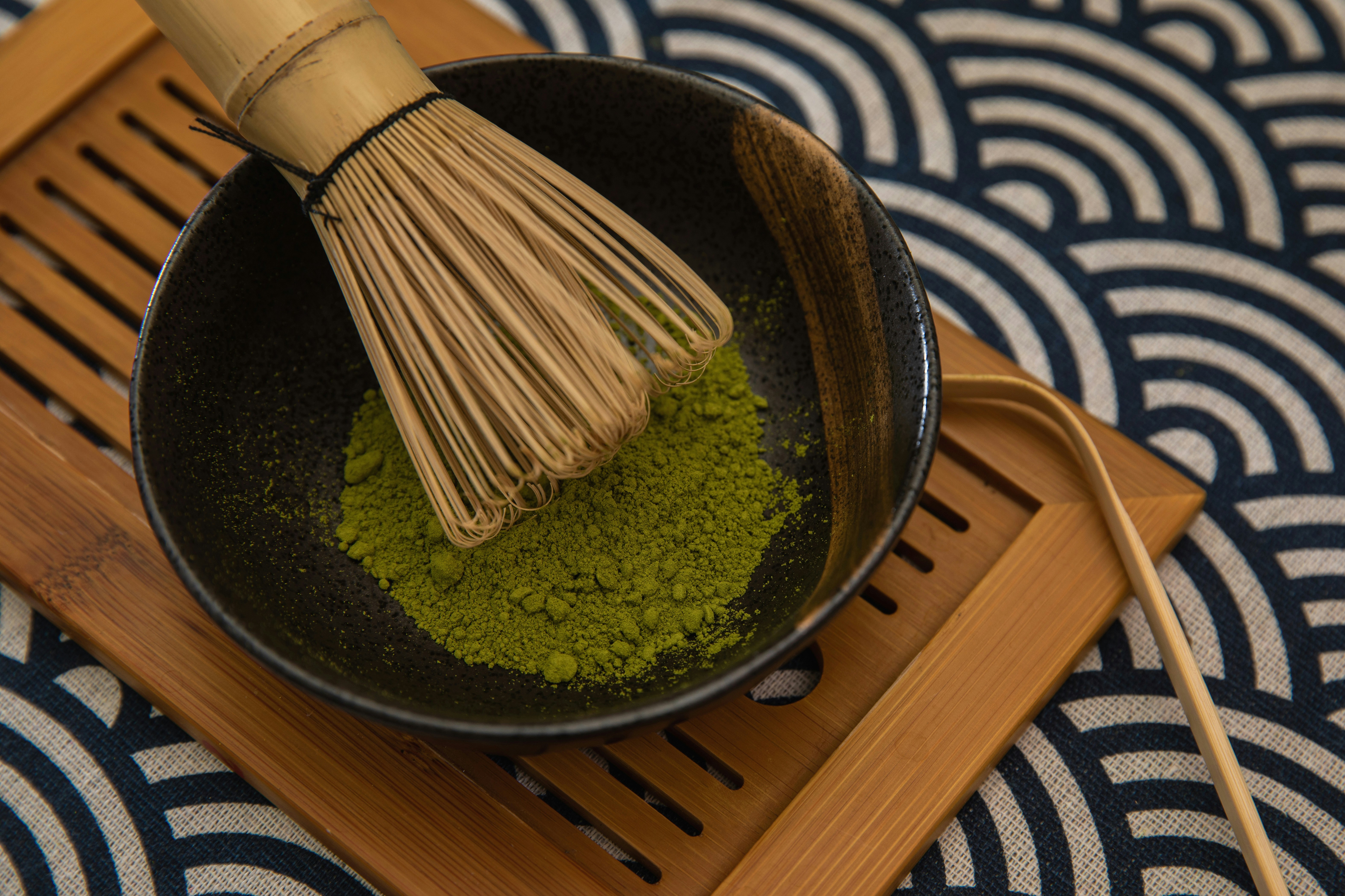 Green Matcha Ritual: Chasen and Powder in a Ceramic Bowl