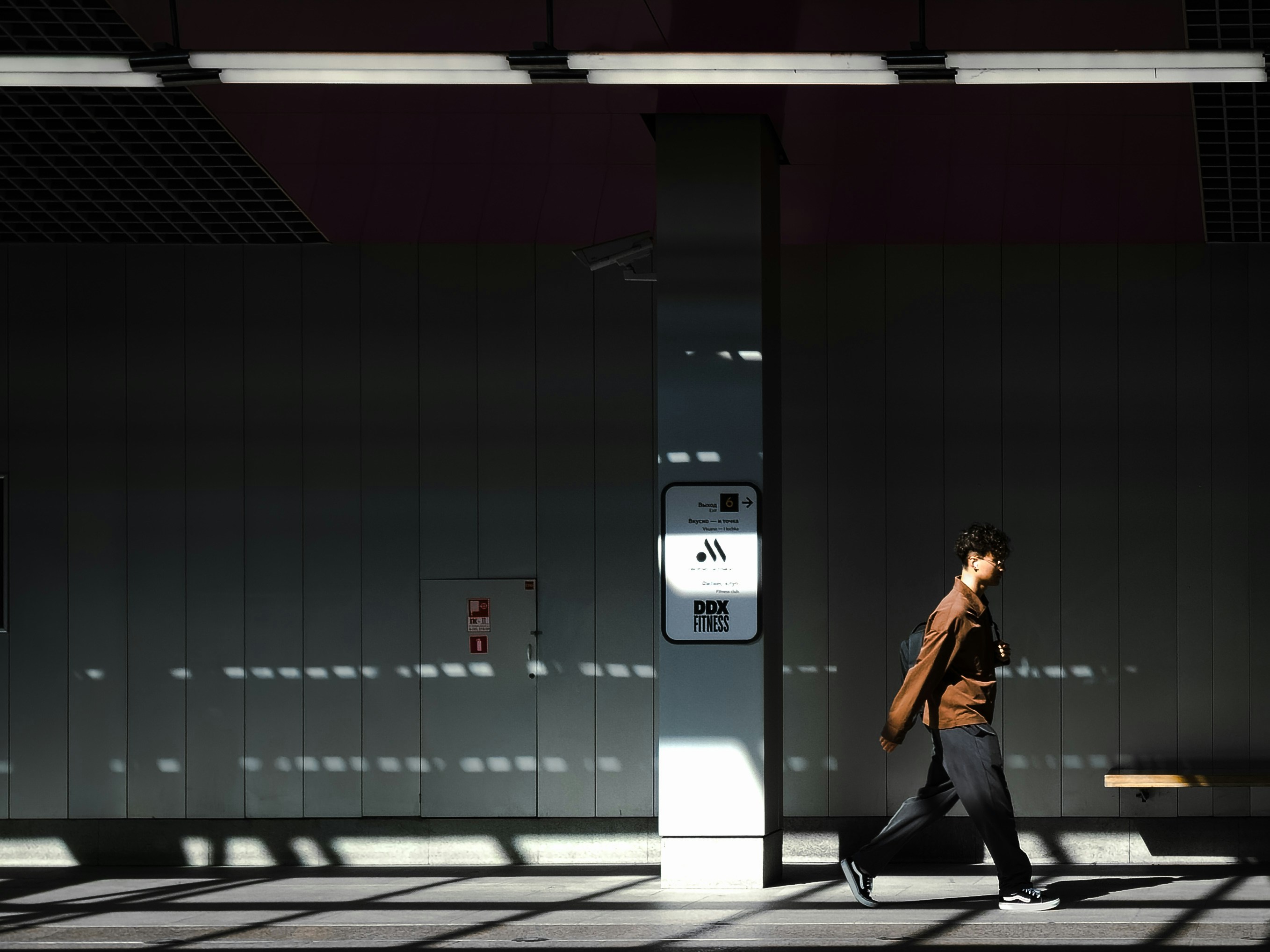 Traveler in Motion: A Quiet Crossing Under Neon Veil