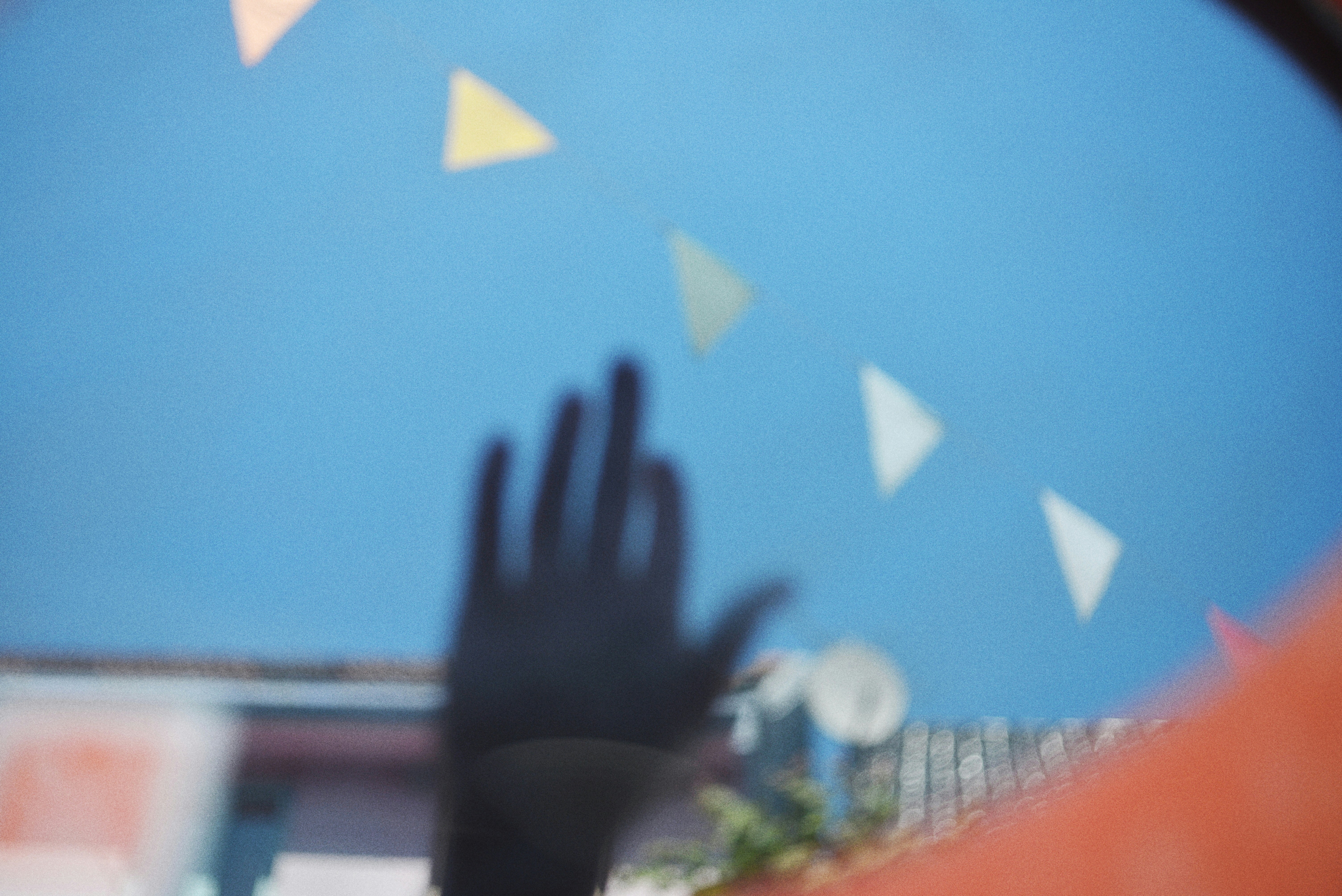 Blue Sky with Hand Silhouette and Painted Triangles