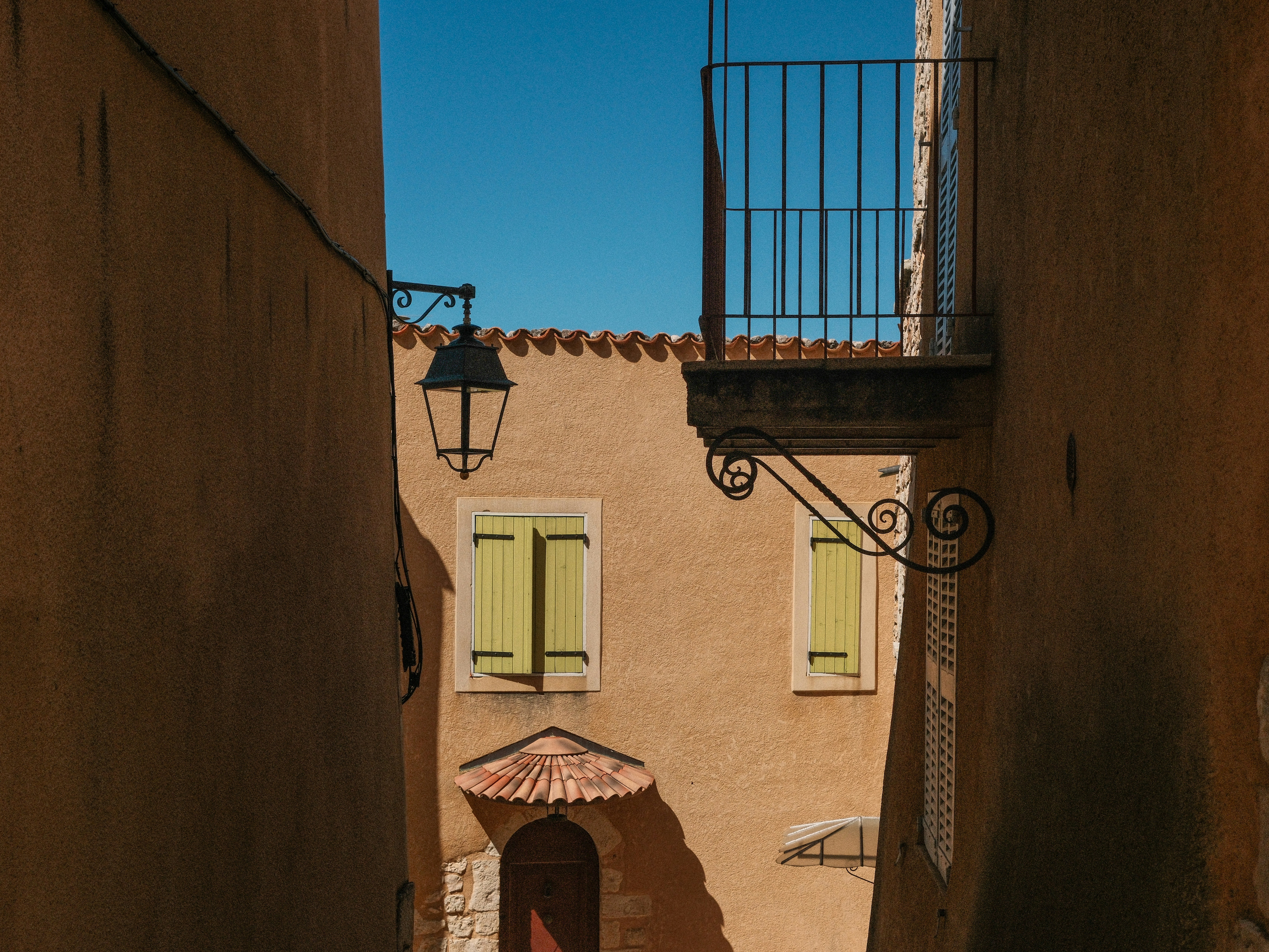 Sunlit Facade Through a Narrow Mediterranean Alley