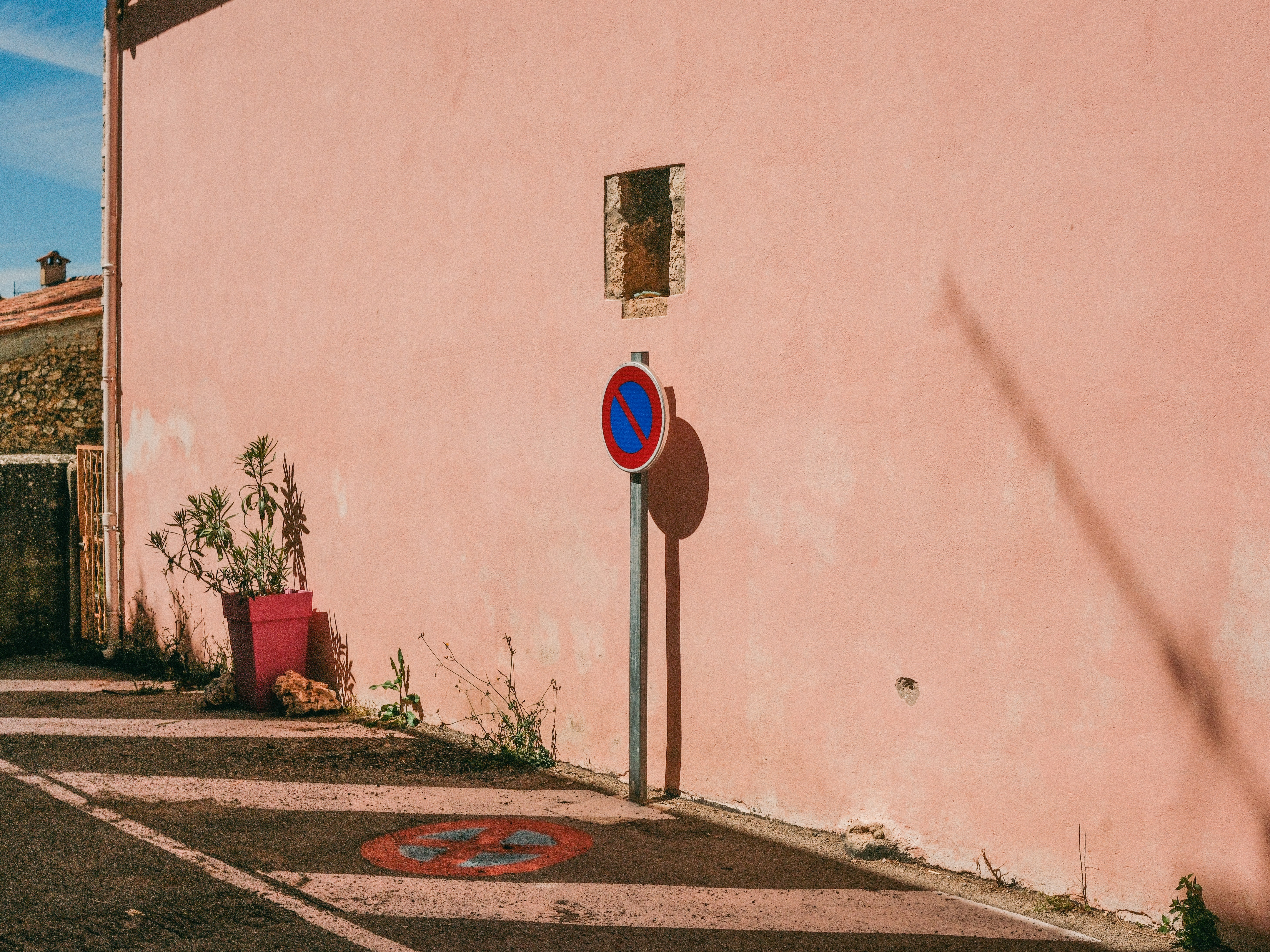 Pastel Wall, Quiet Street, and a Silent No-Parking Sign
