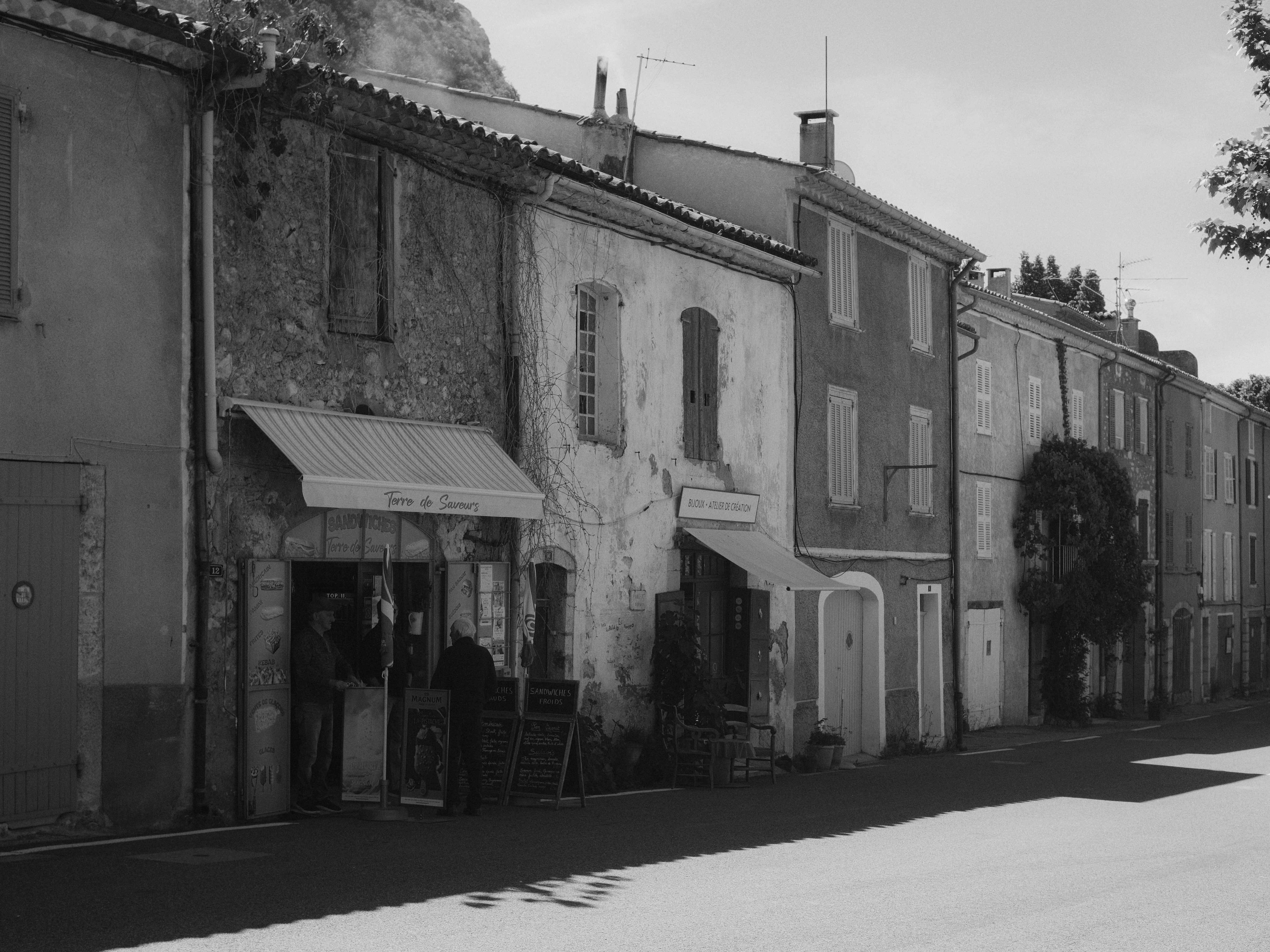 Quiet Arcades: A Sunlit Street of Shuttered Shops