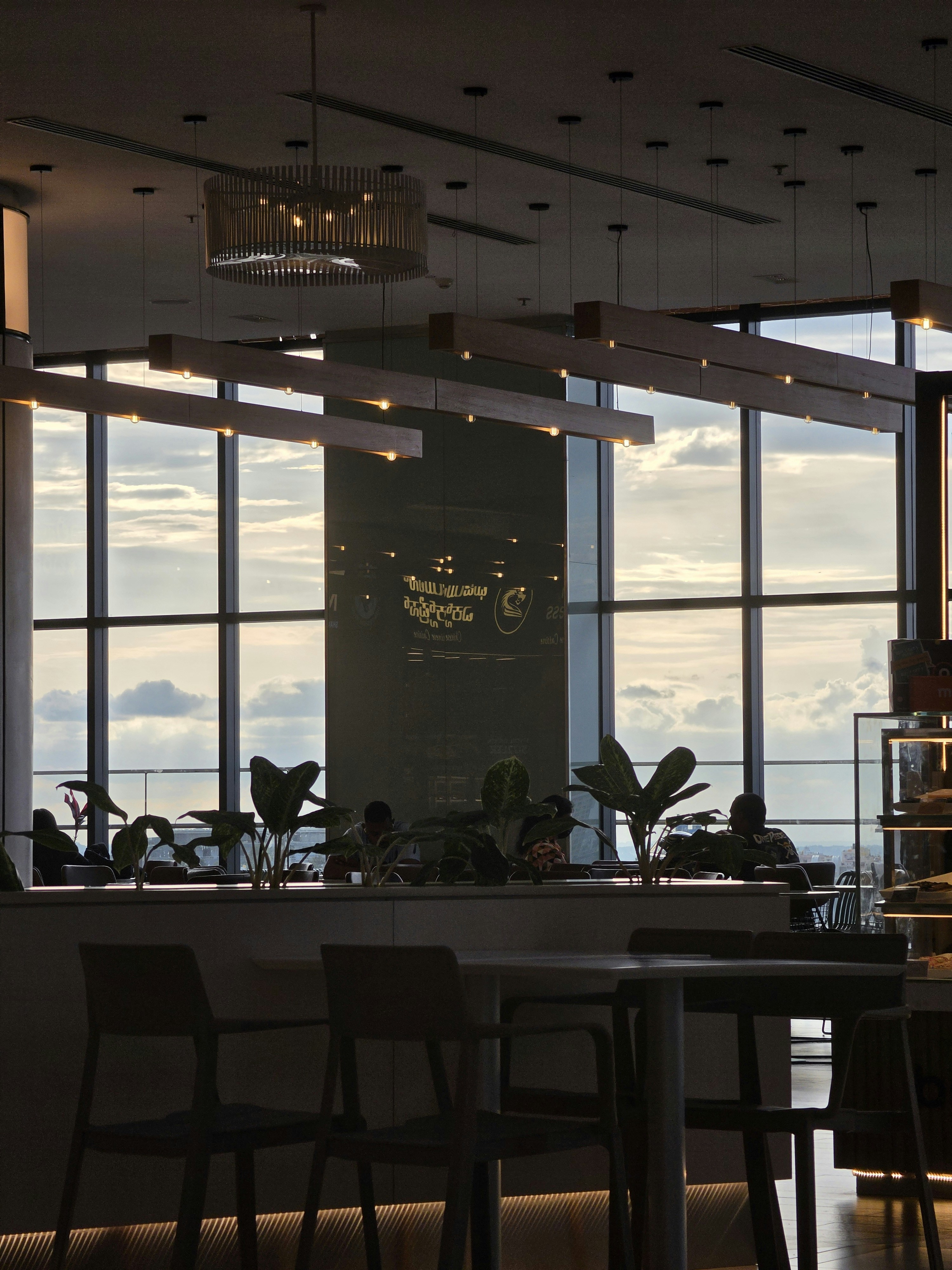 Sunlit Atrium Café Amid Silhouetted Tables