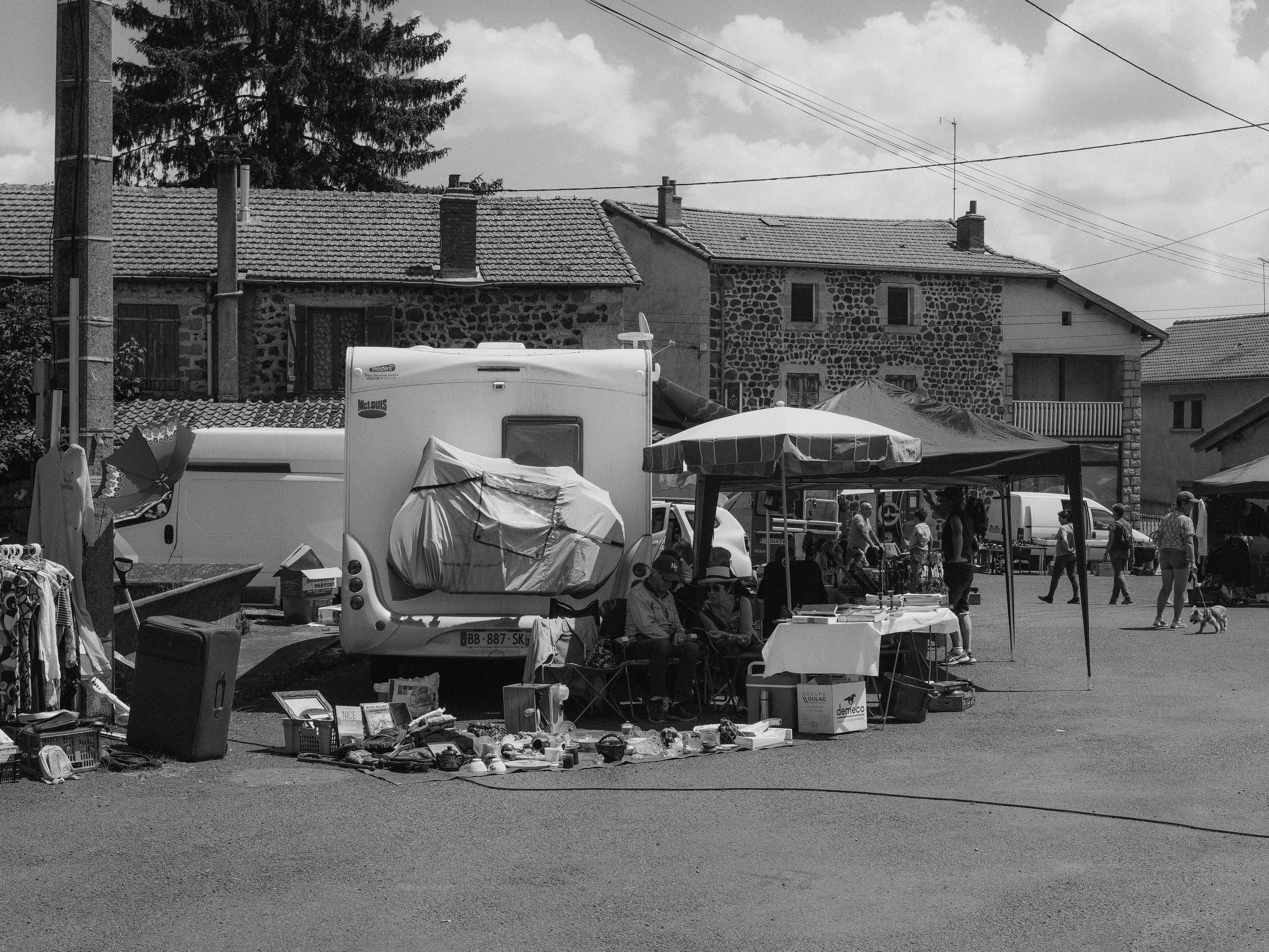 Street Market Aftermath: A Quiet Heap of Goods Beside a Camper