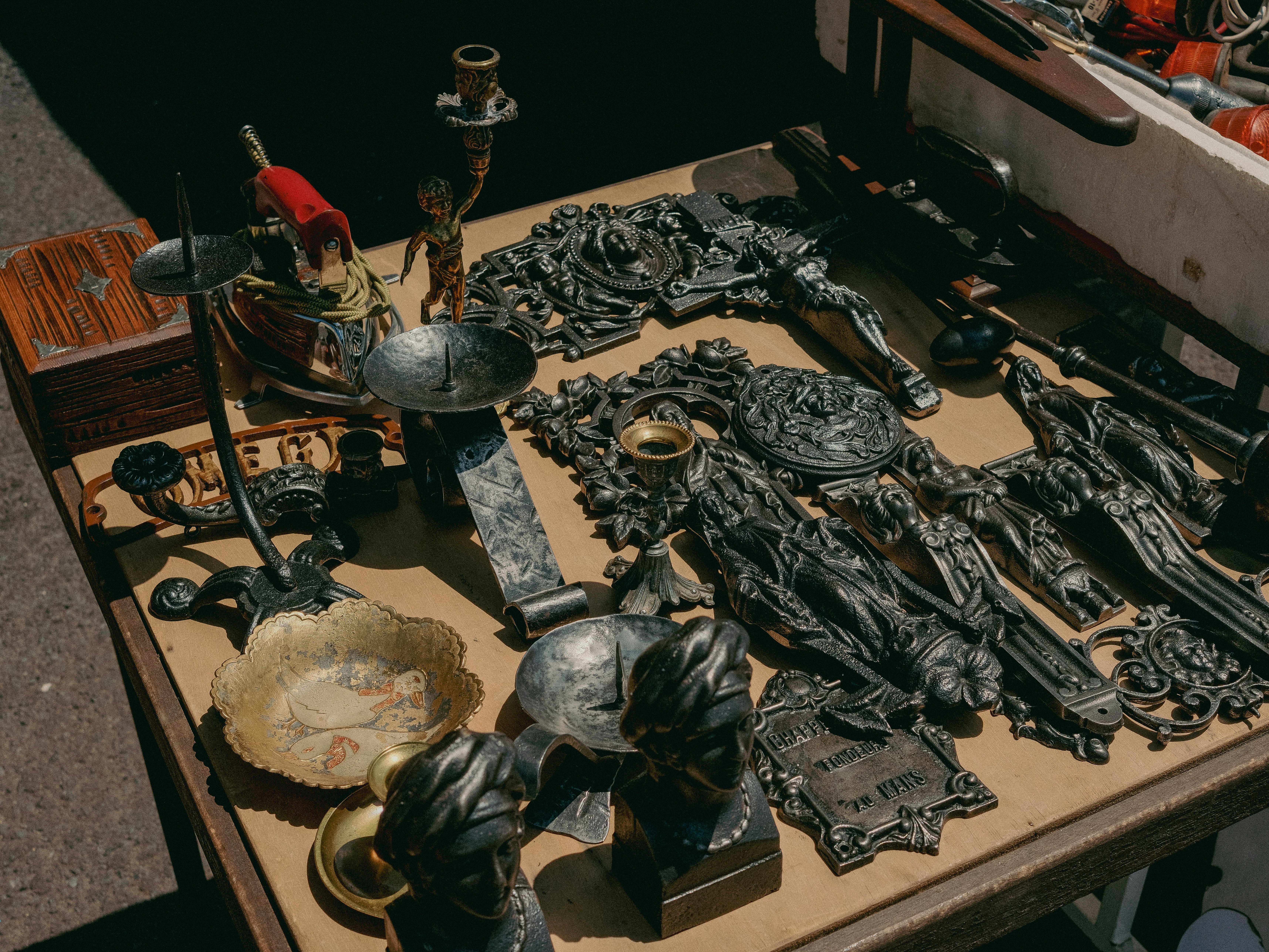 Treasure Trove of Cast Metal: Detailing Vintage Finds on a Wooden Table