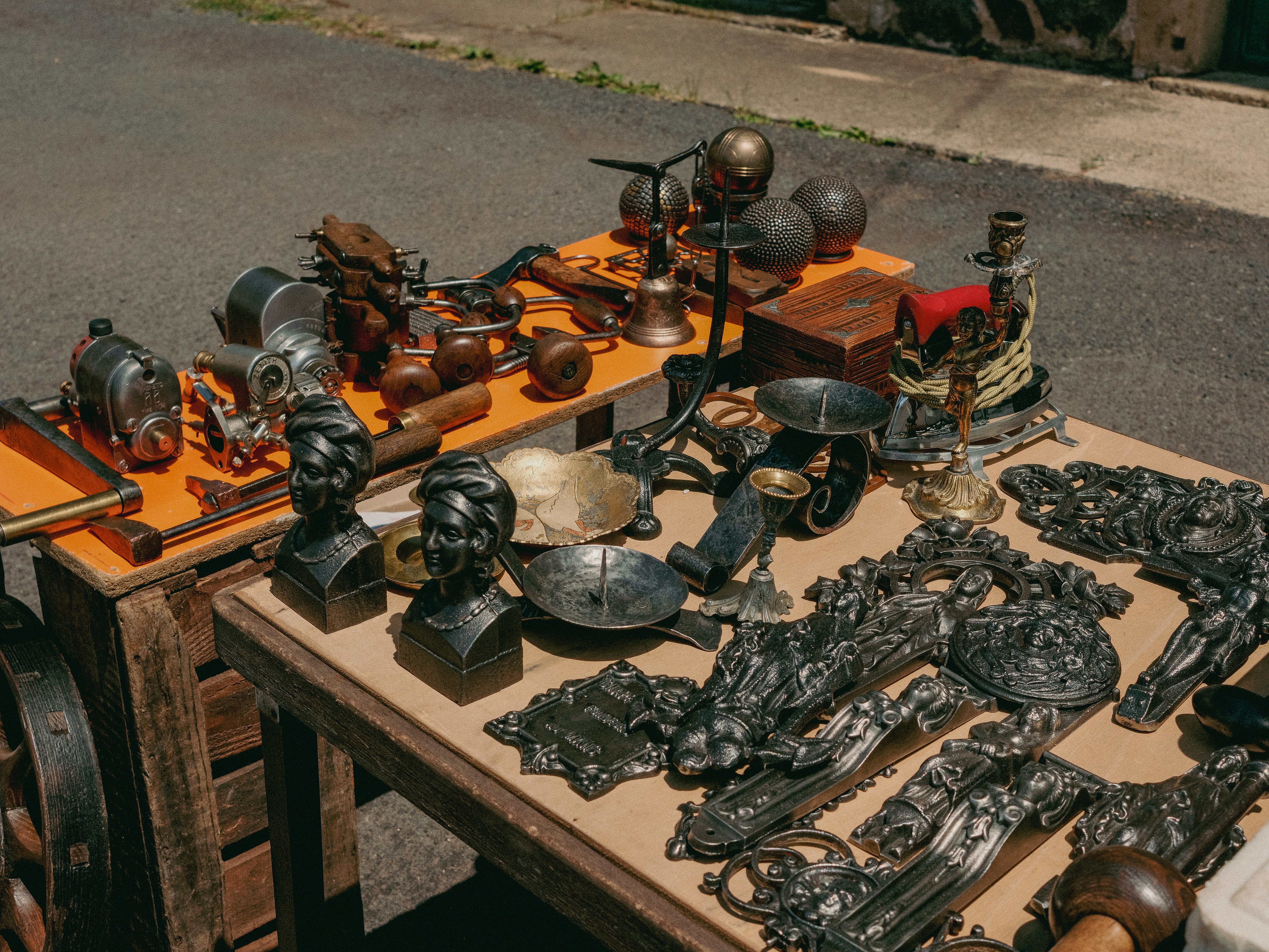 Ornate Metalworks on Weathered Table: A Quiet Market of Vintage Objects