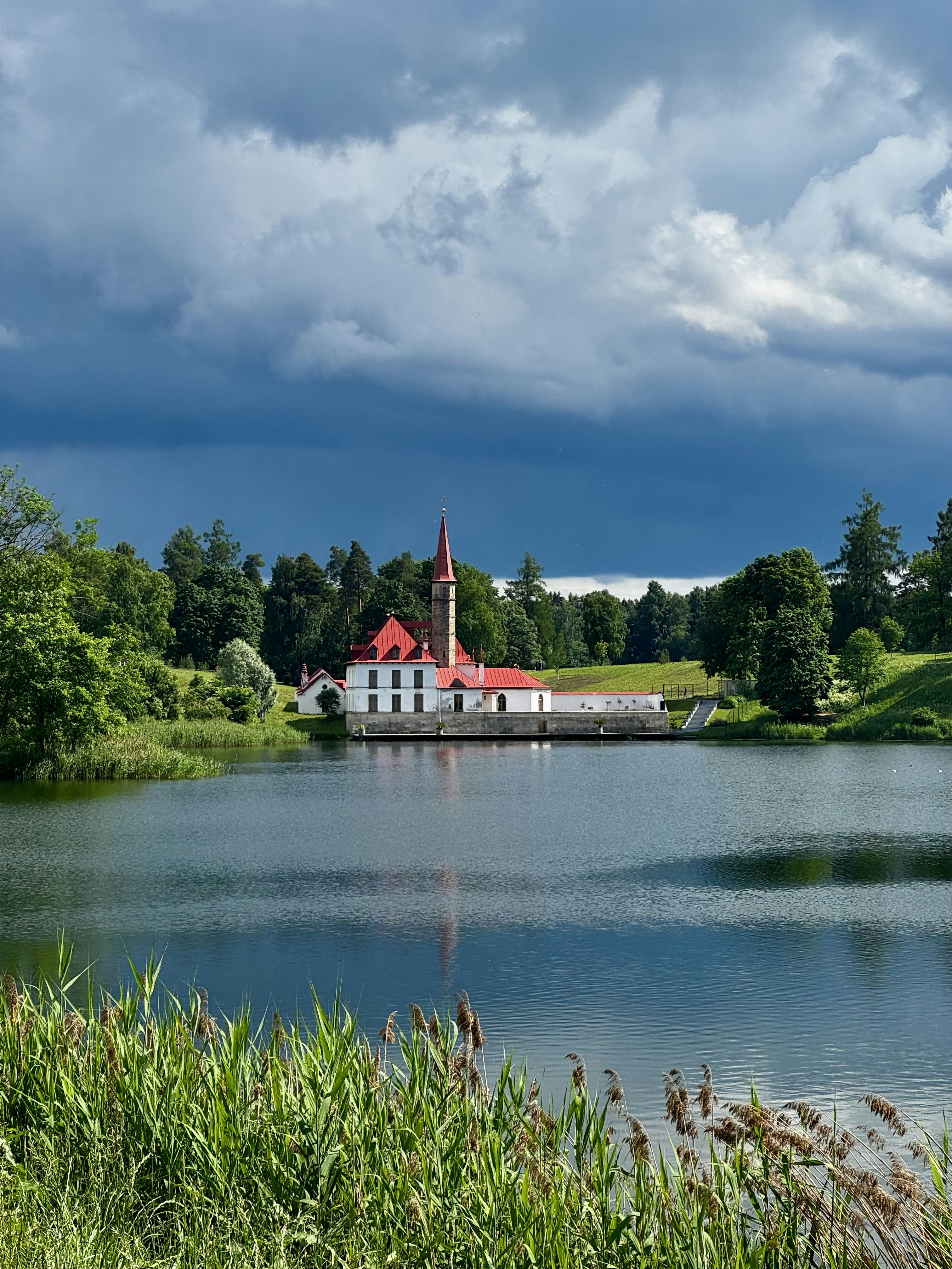 Red-roofed chapel on a tranquil lakeside