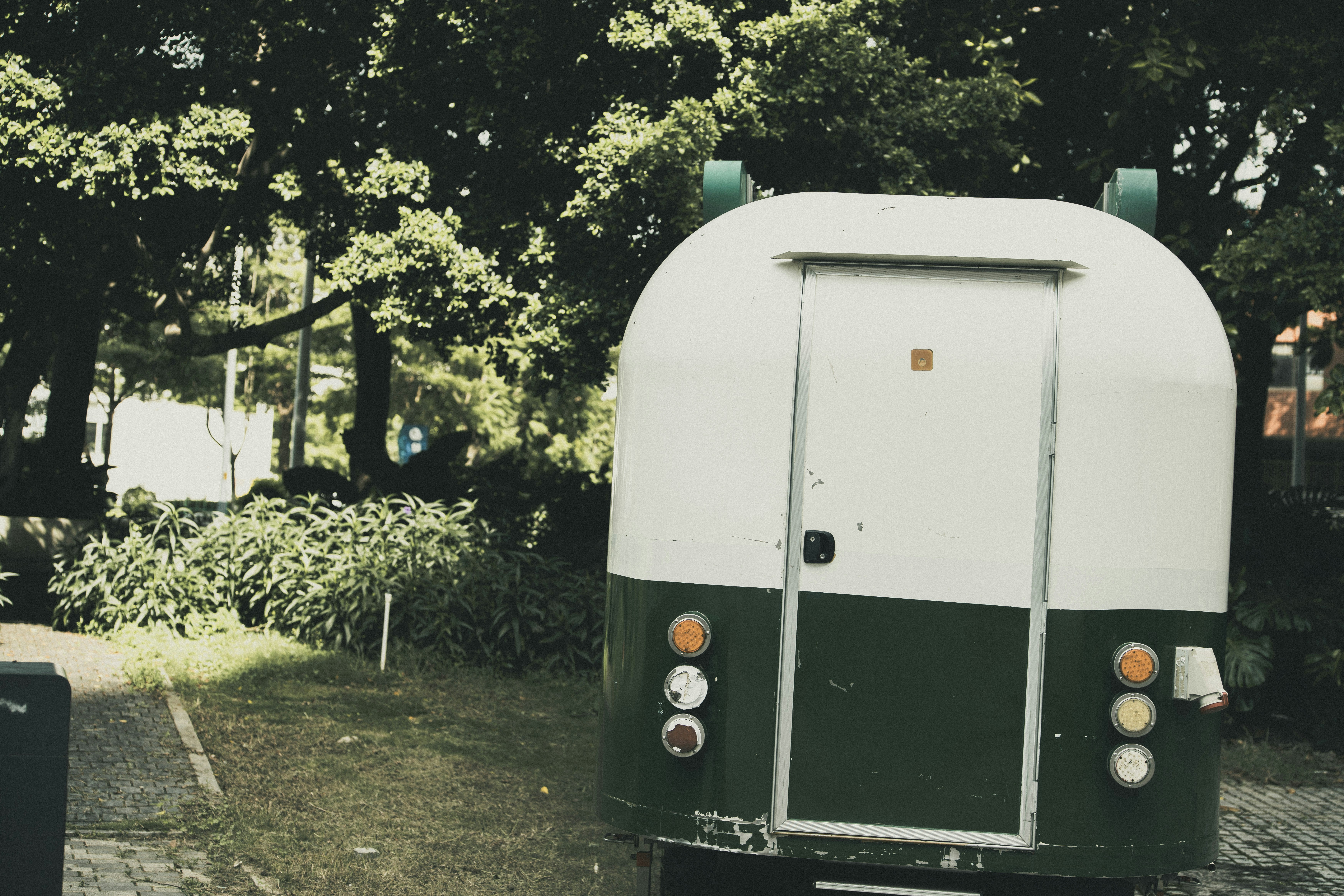 Urban camper: a retro trailer tucked into a sunlit park