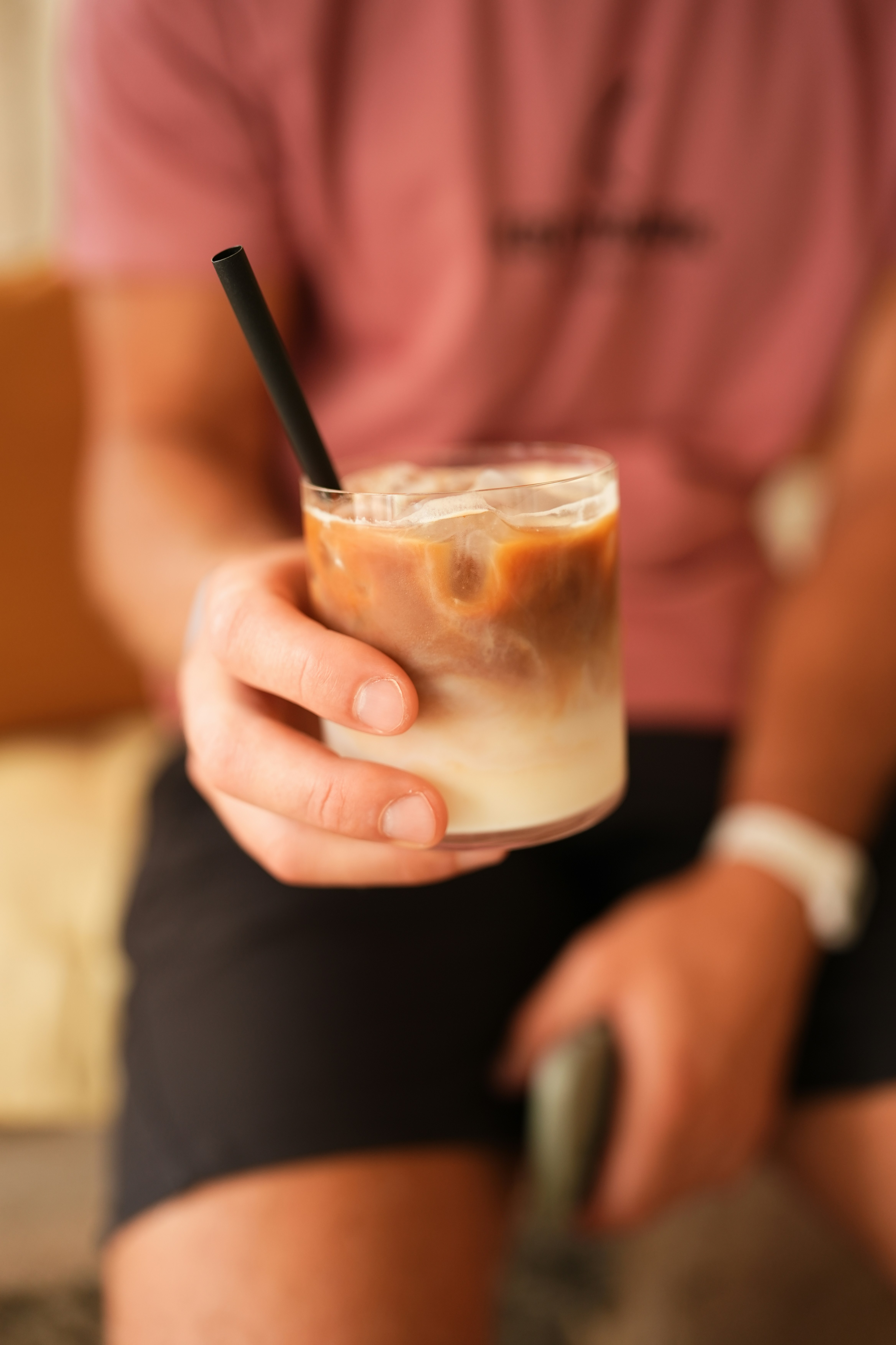 A Quiet Moment with a Creamy Sip: The Hand and Drink in Soft Focus