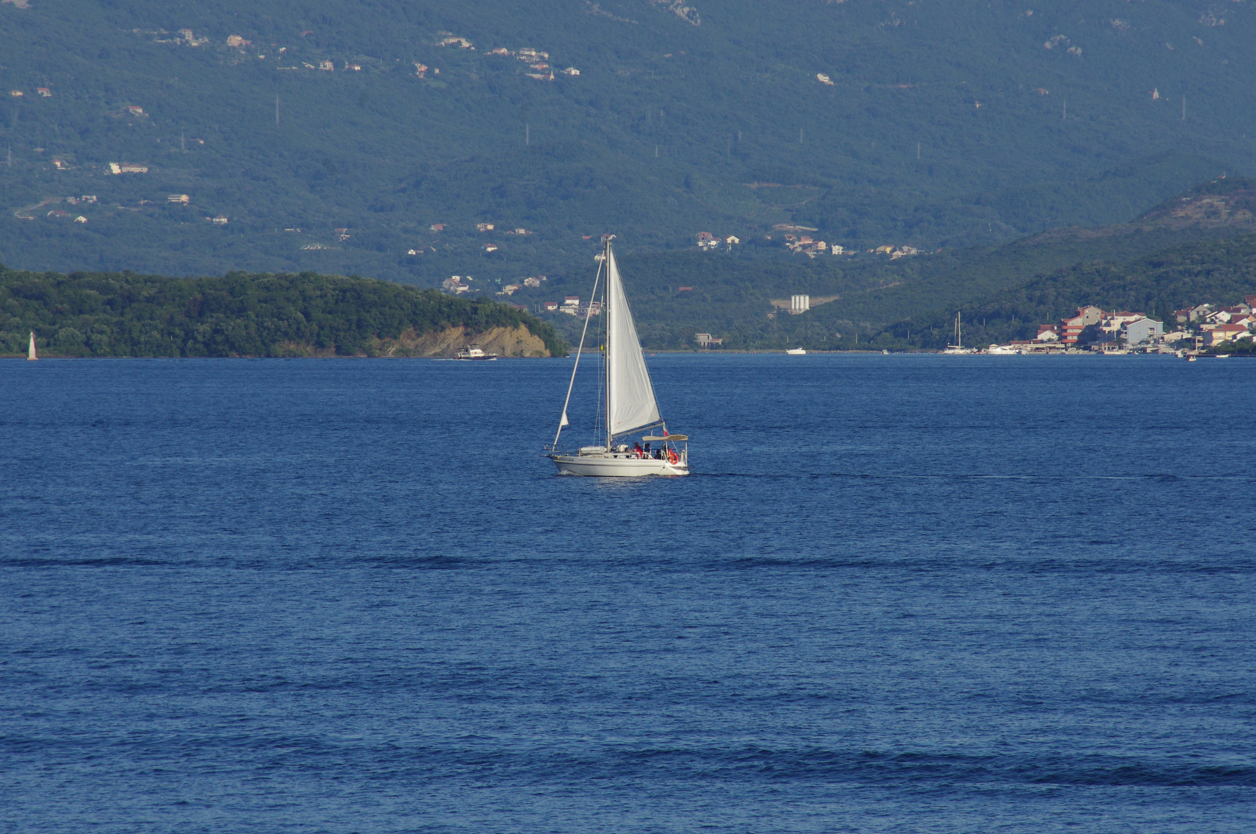 Sailing Solo: A Quiet Boat Glides Across Blue Horizons