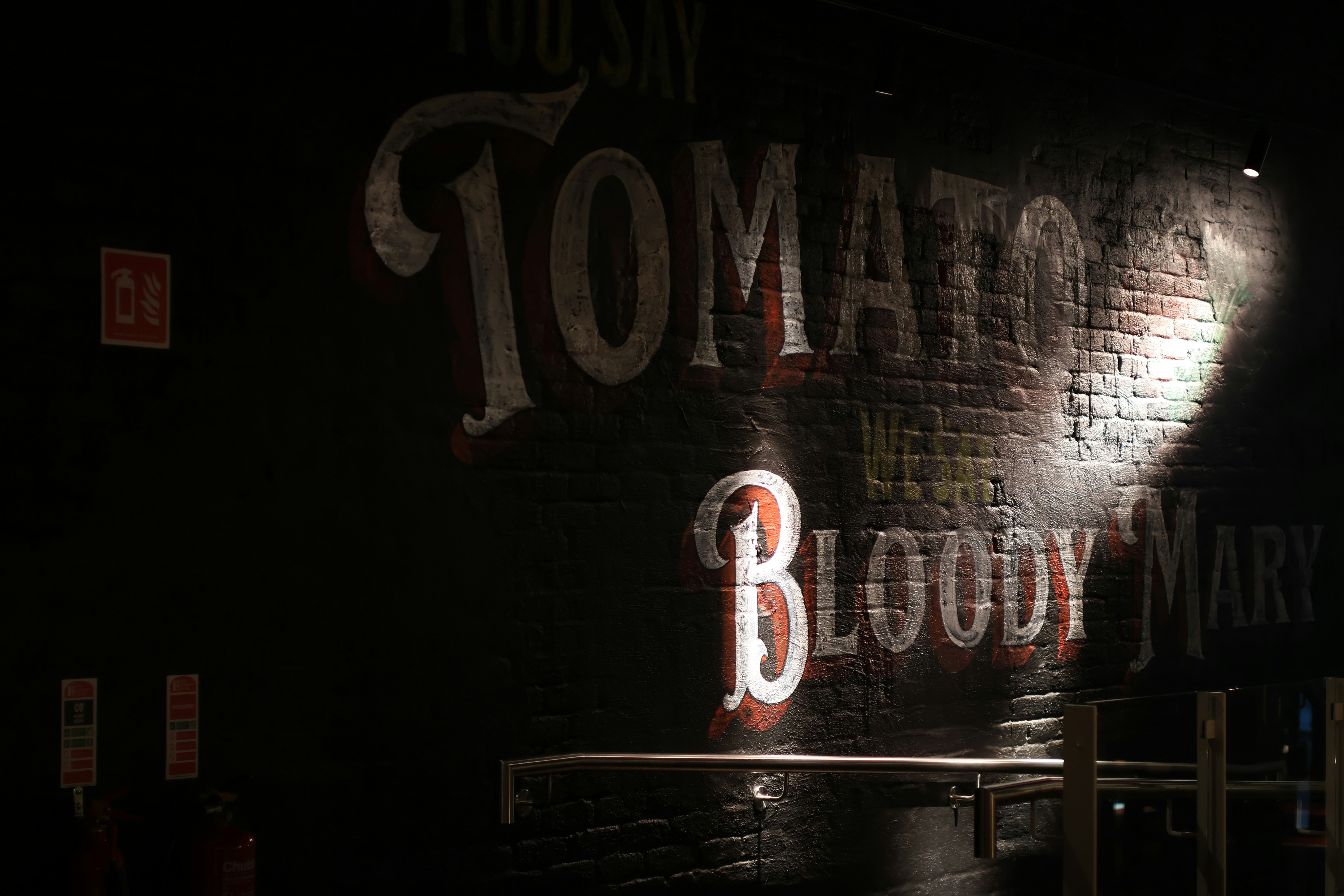 Dim Gallery Glow on a Tomatoes-Themed Brick Wall