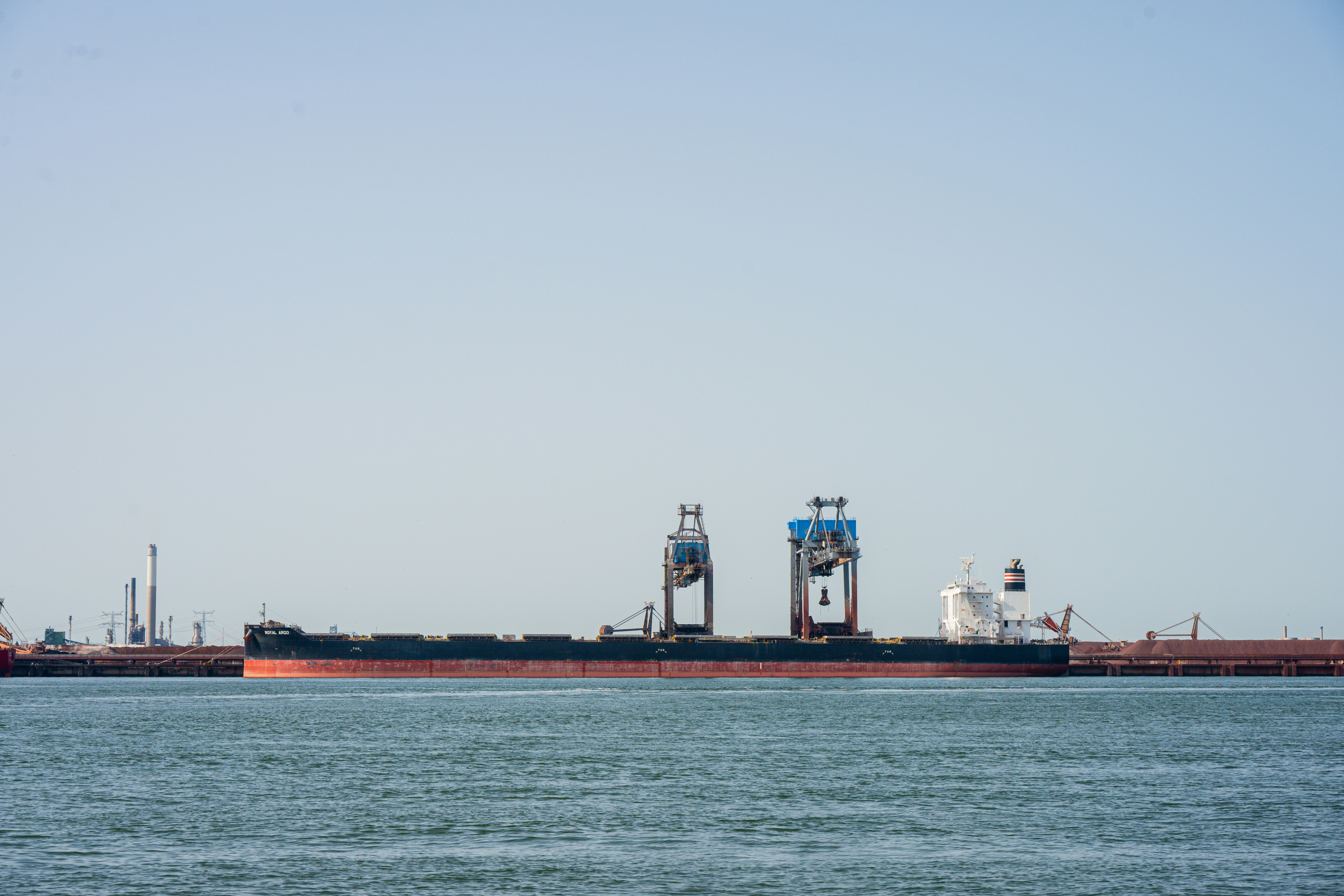 Harbor Giants: Two Cranes Standing Guard over the Quiet Deck