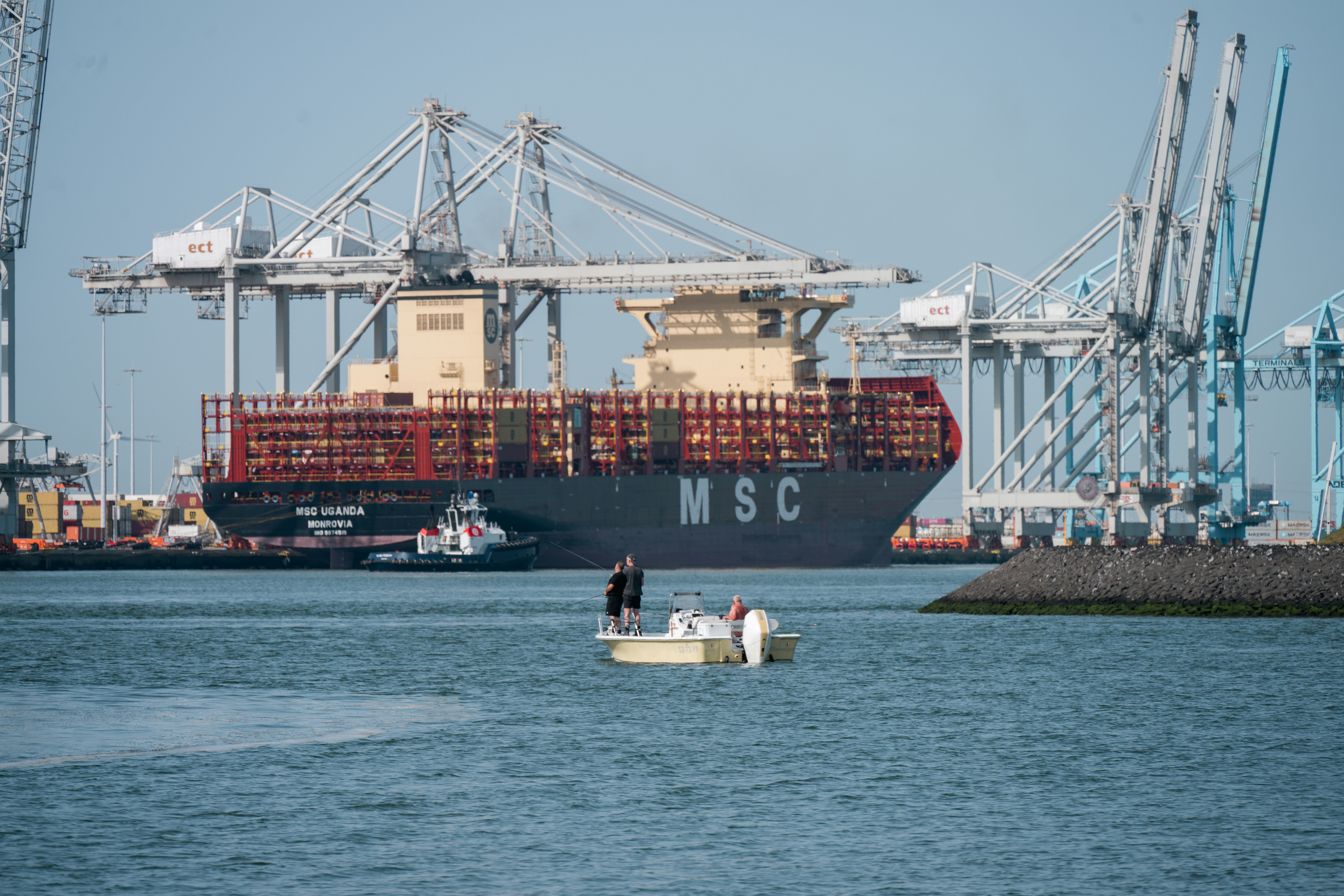 Toward the Horizon: A Container Ship and Small Boat in a Busy Port