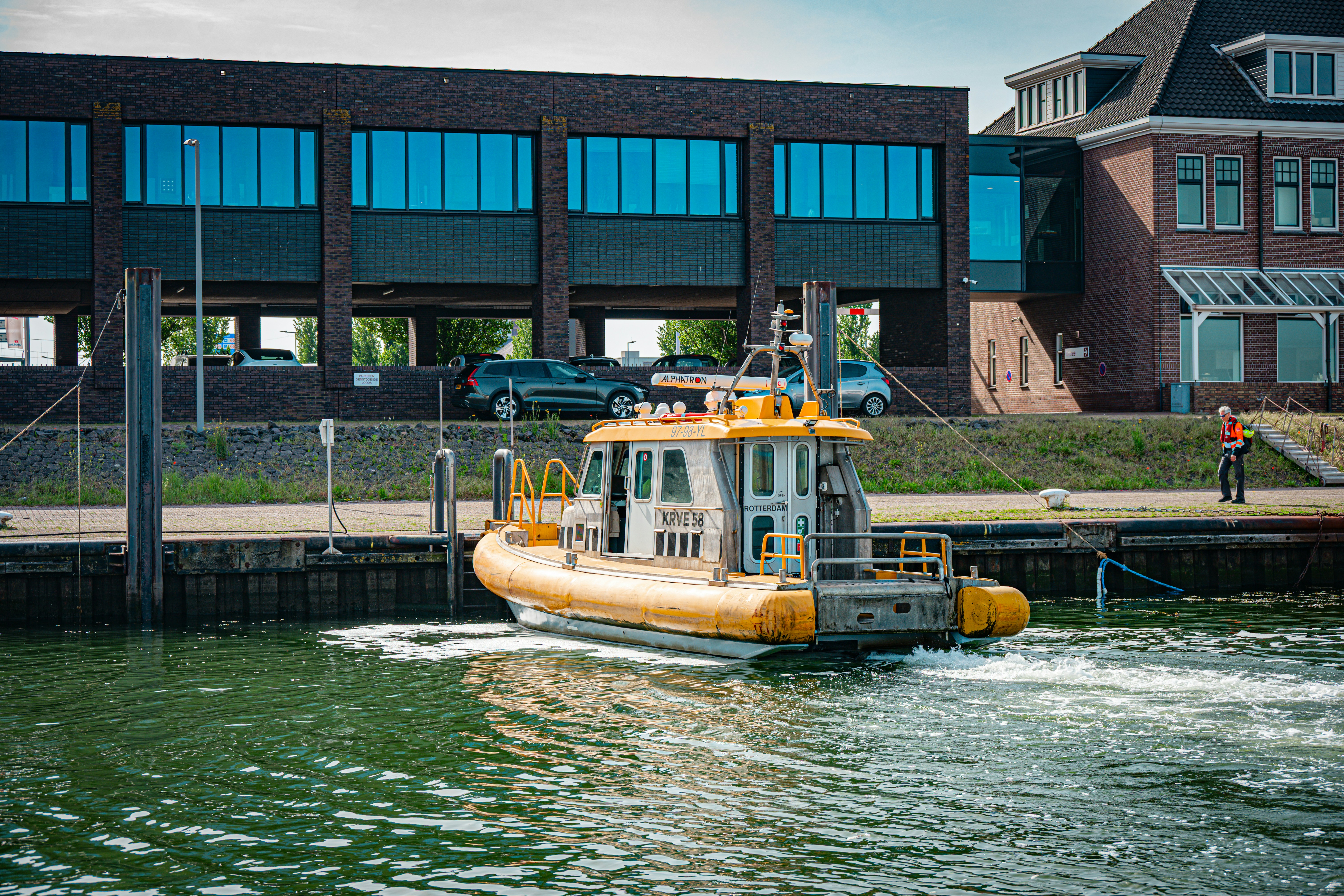 Towboat in the Channel: Urban backdrop and blue-green water