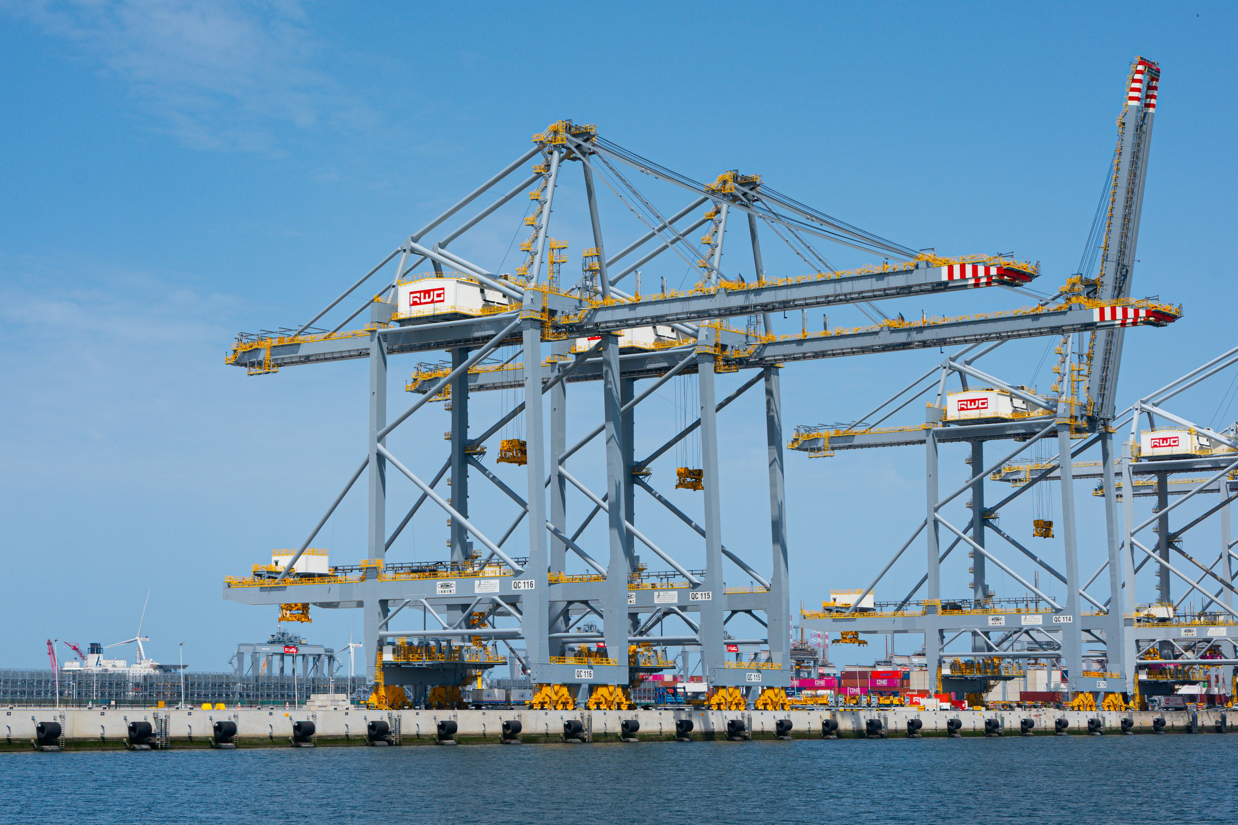 Harbor Giants: Port Cranes Standing Against a Clear Sky