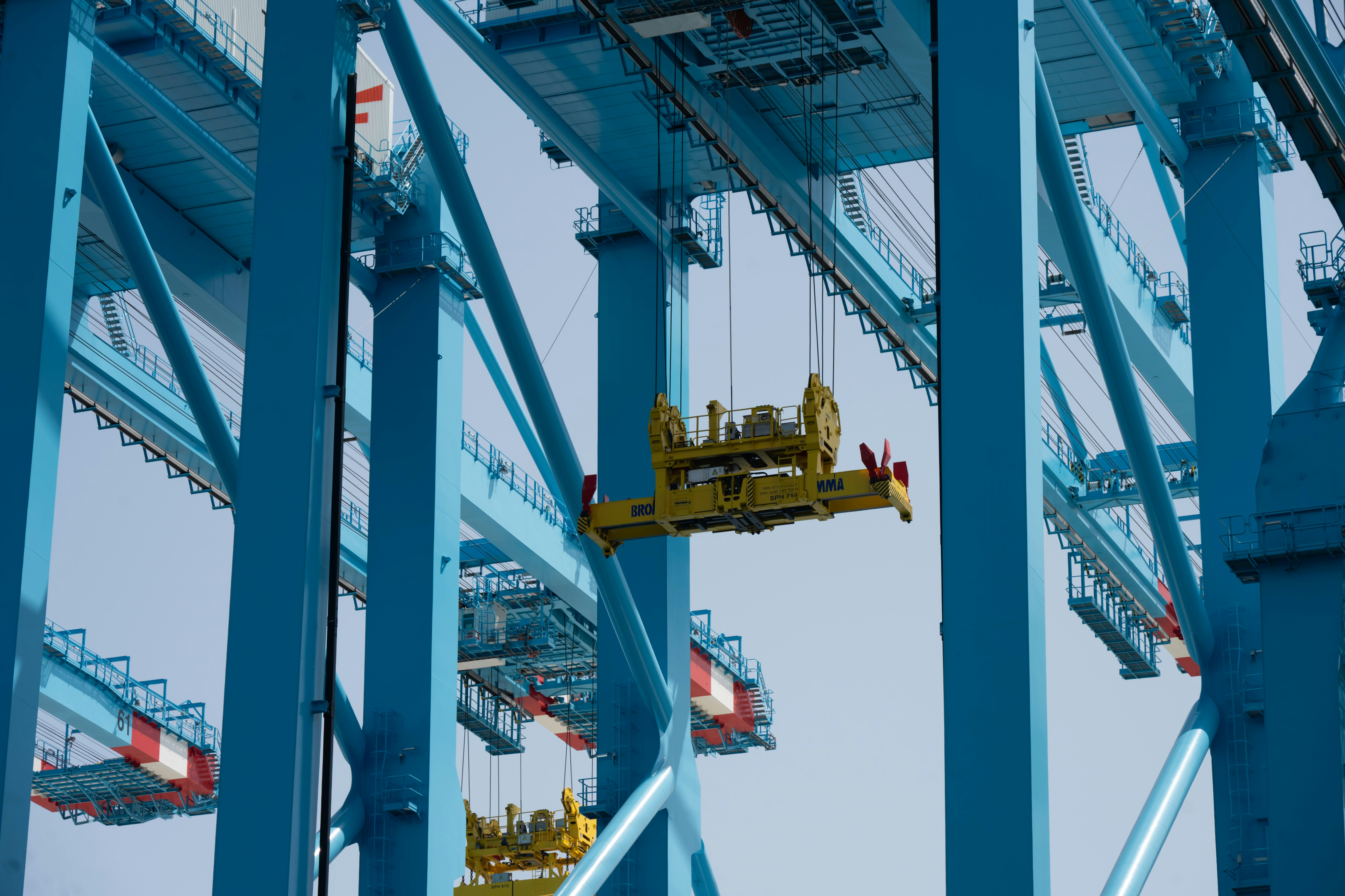 Blue Structural Giants: Cranes Framed Against Sky