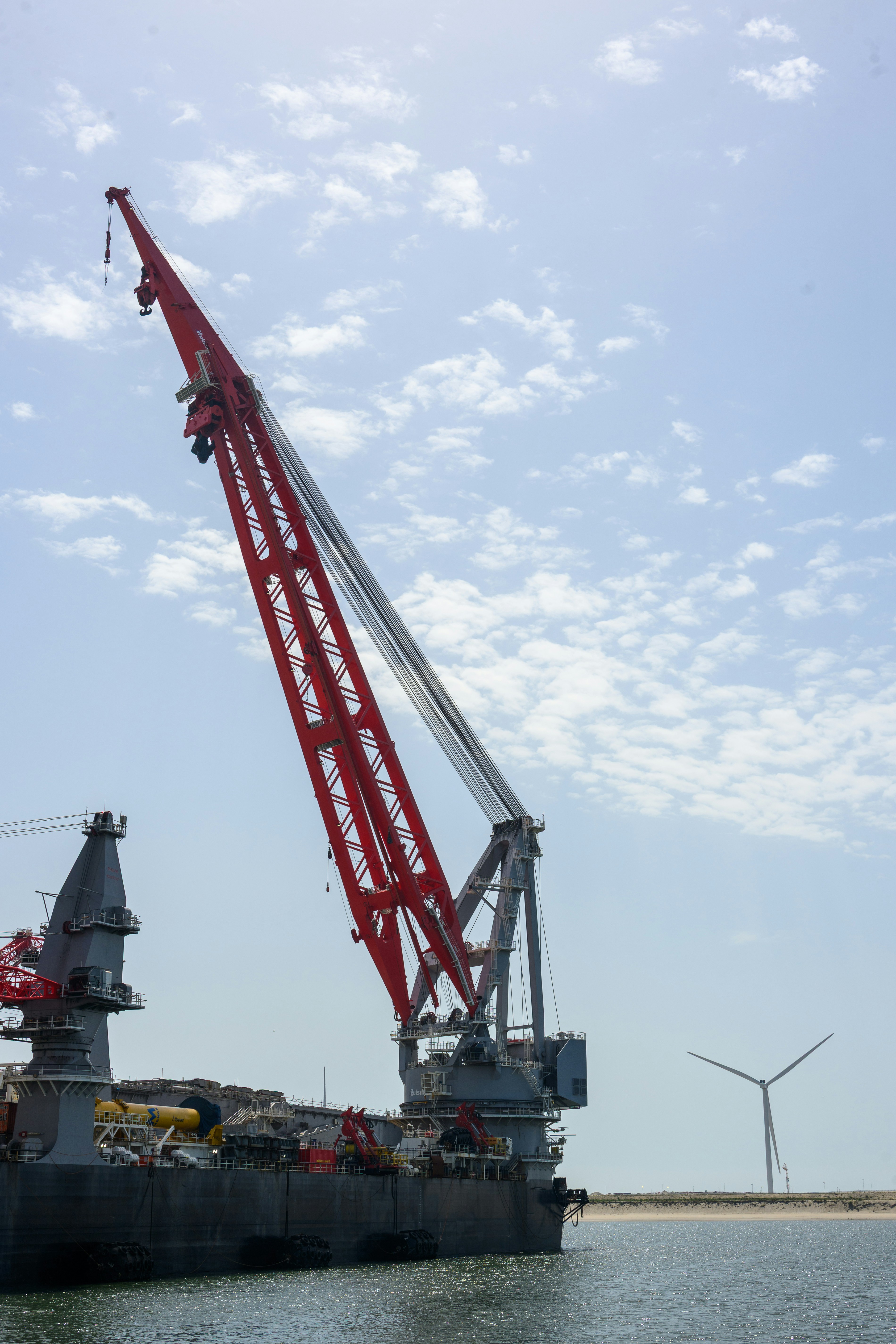 Crane Bows Over the Sea: A Coastal Construction Scene