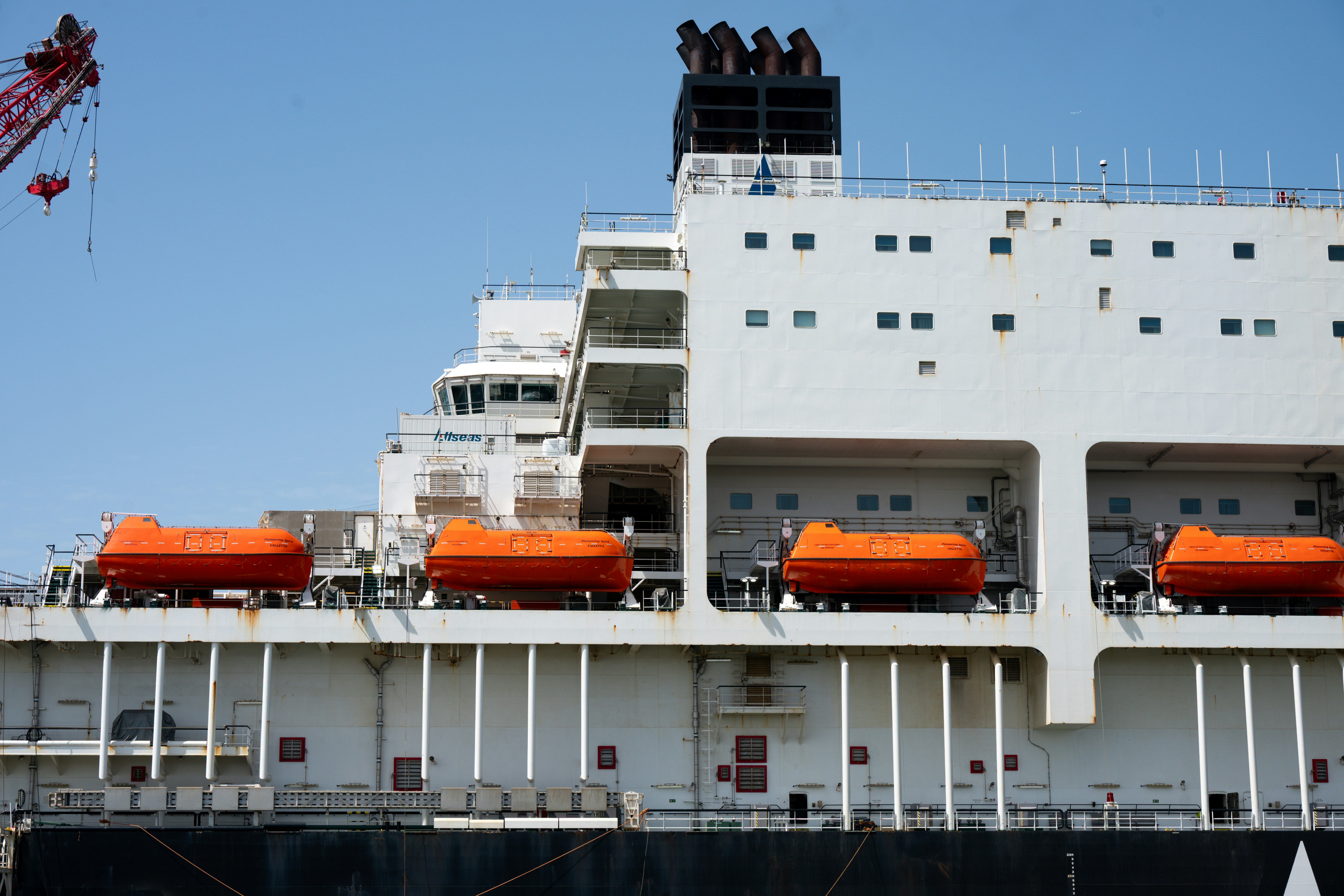 Orange Lifeboats Aligned on a Giant Vessel