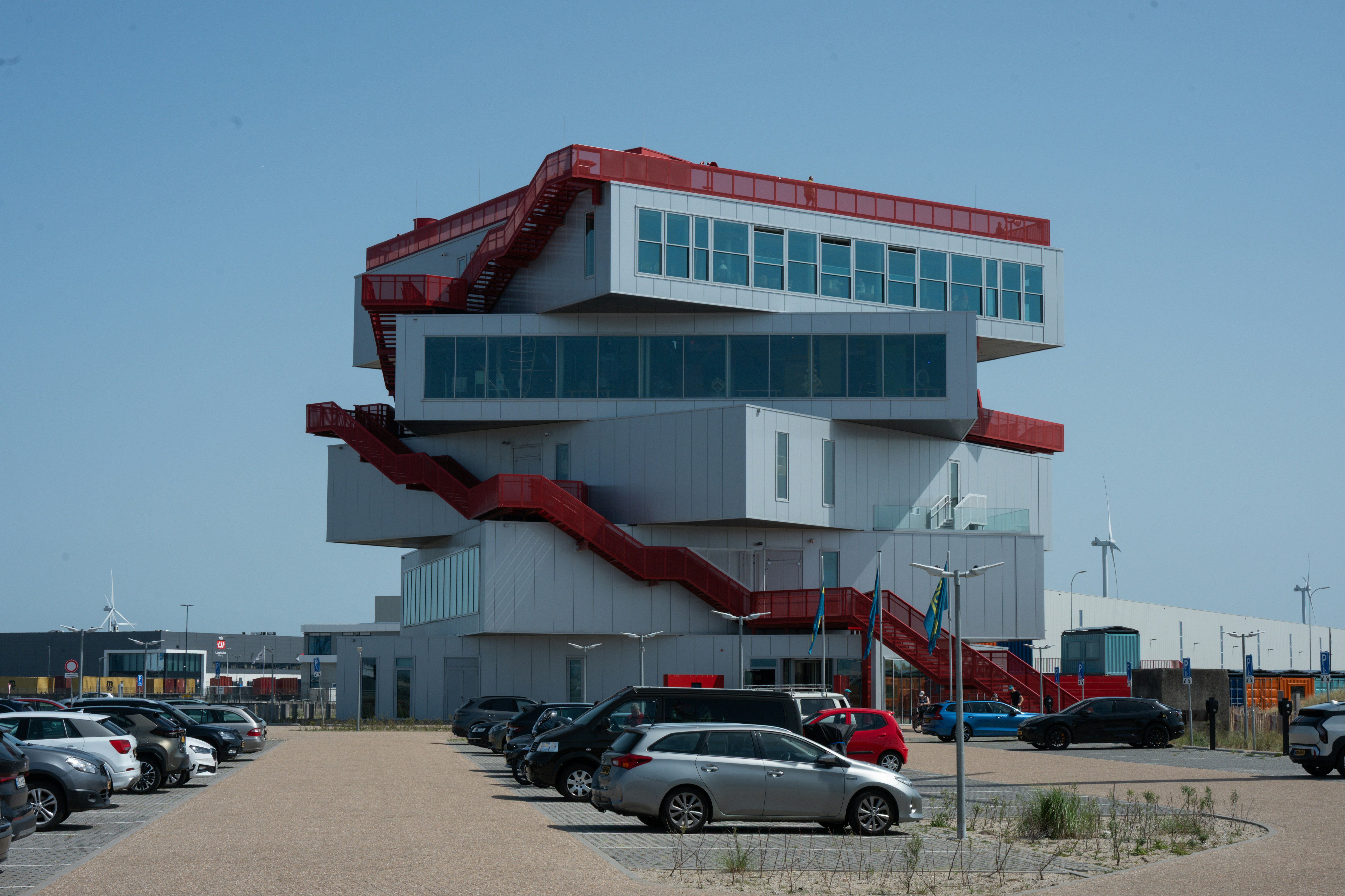 Towering Contours: A Modernist Control Center Rising from the Parking Lot