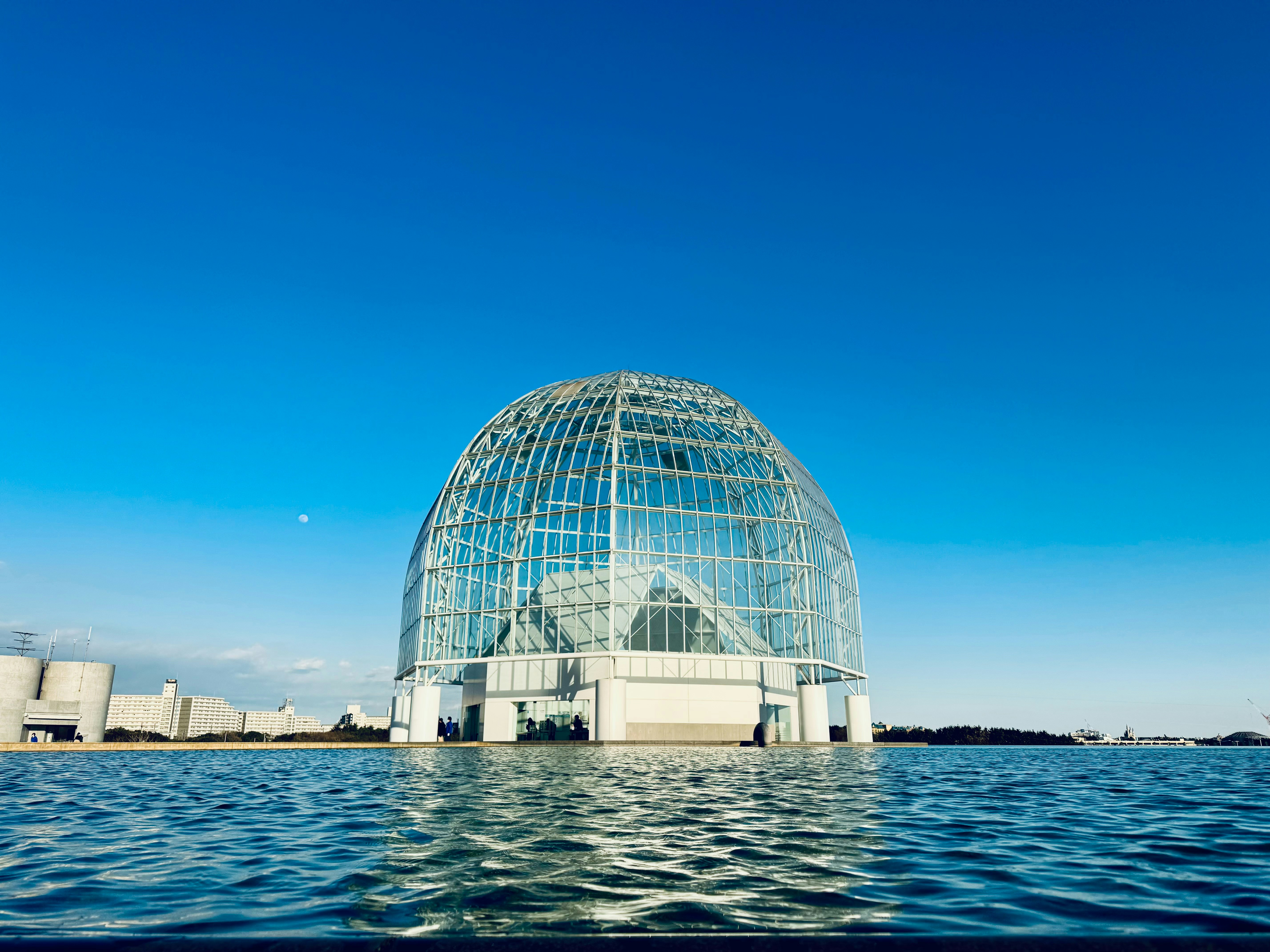 Glass Dome Rising from the Calm Waterfront