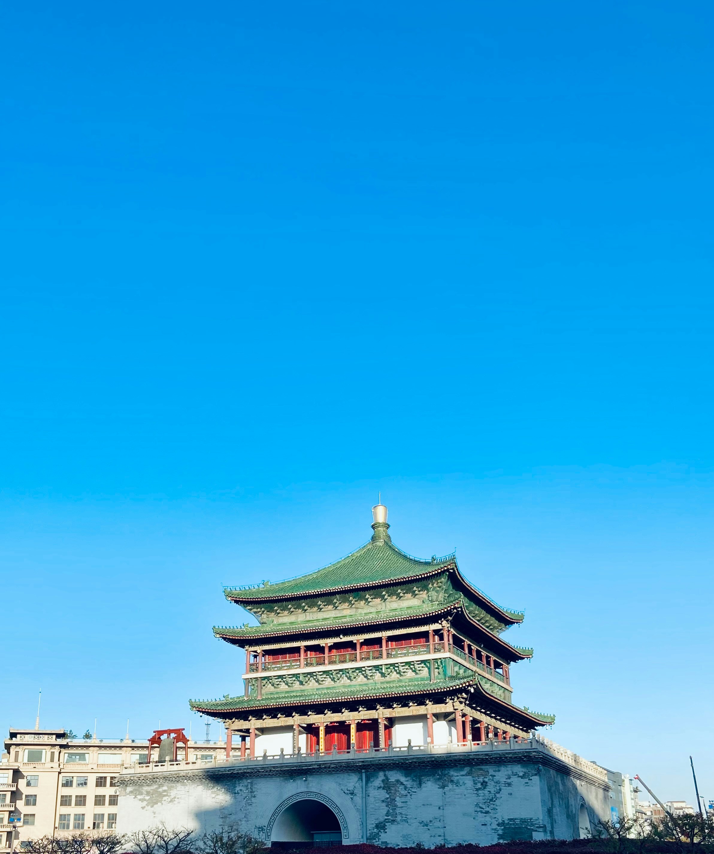 Temple in Clear Sky: A Green-Topped Pagoda Emerges from an Ancient Gate