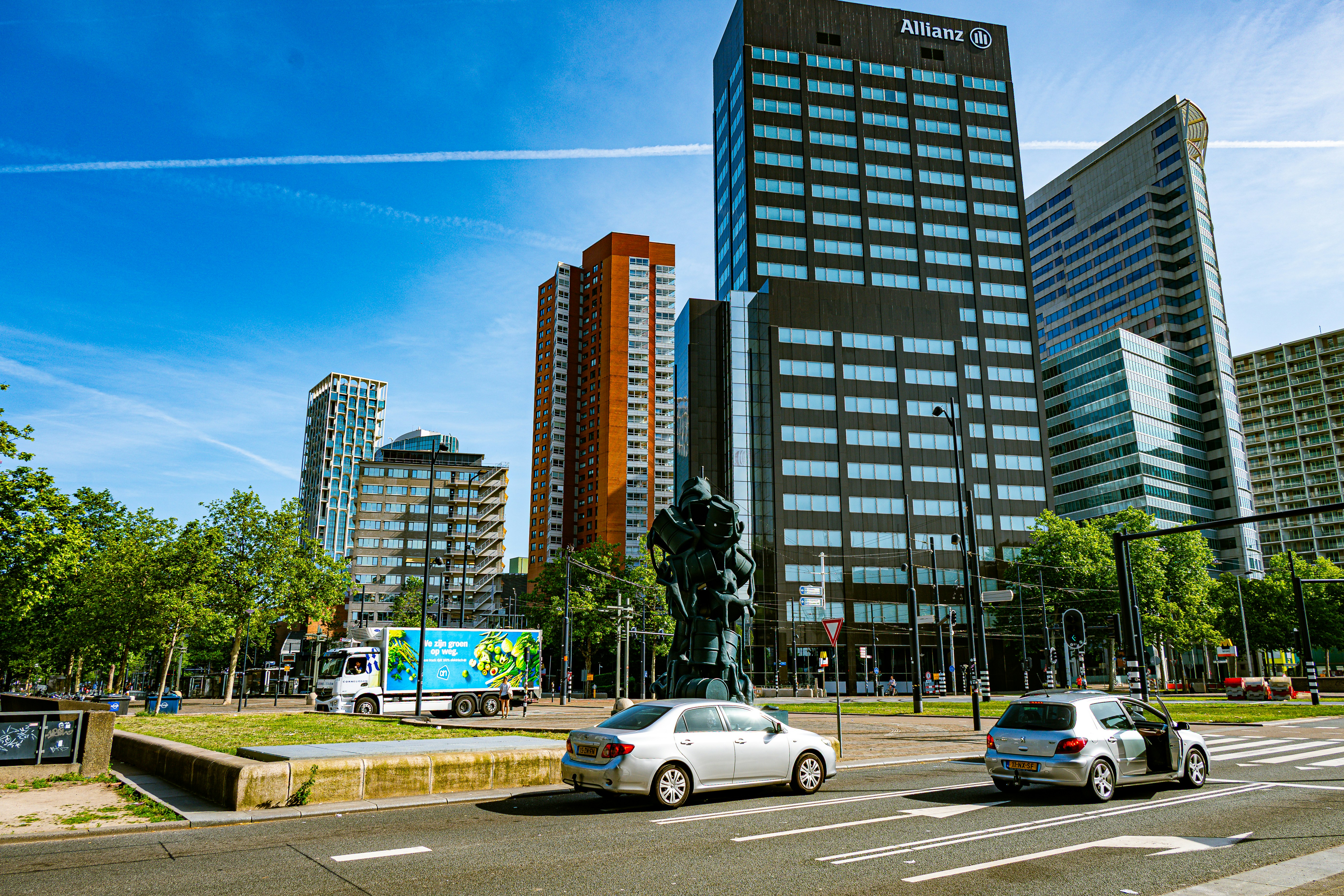 Skyline Vigil: A City Square Framed by Glass Towers and a Bronze Statue