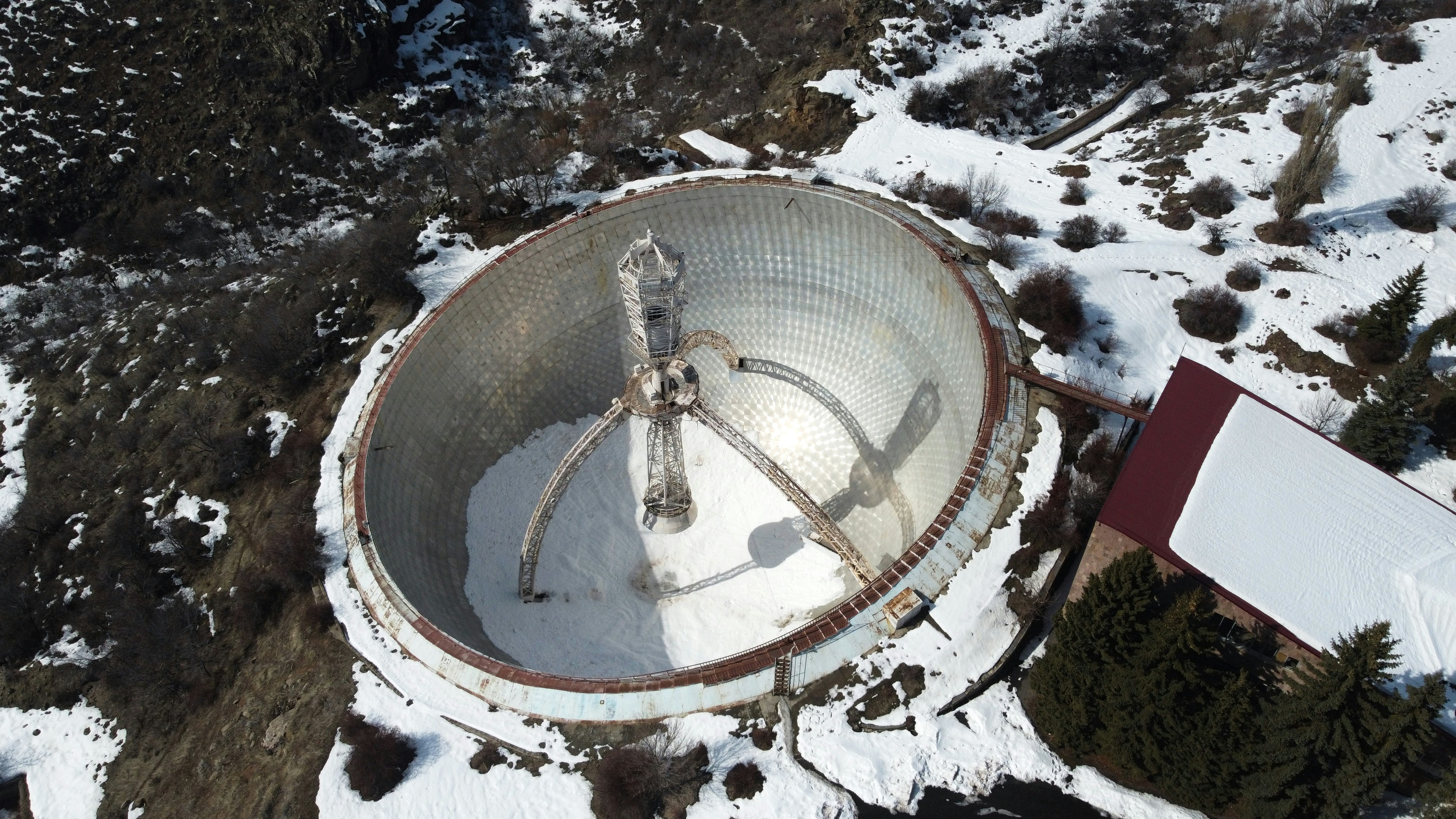 Snowbound Dish: Aerial View of a Circular Observatory Dome