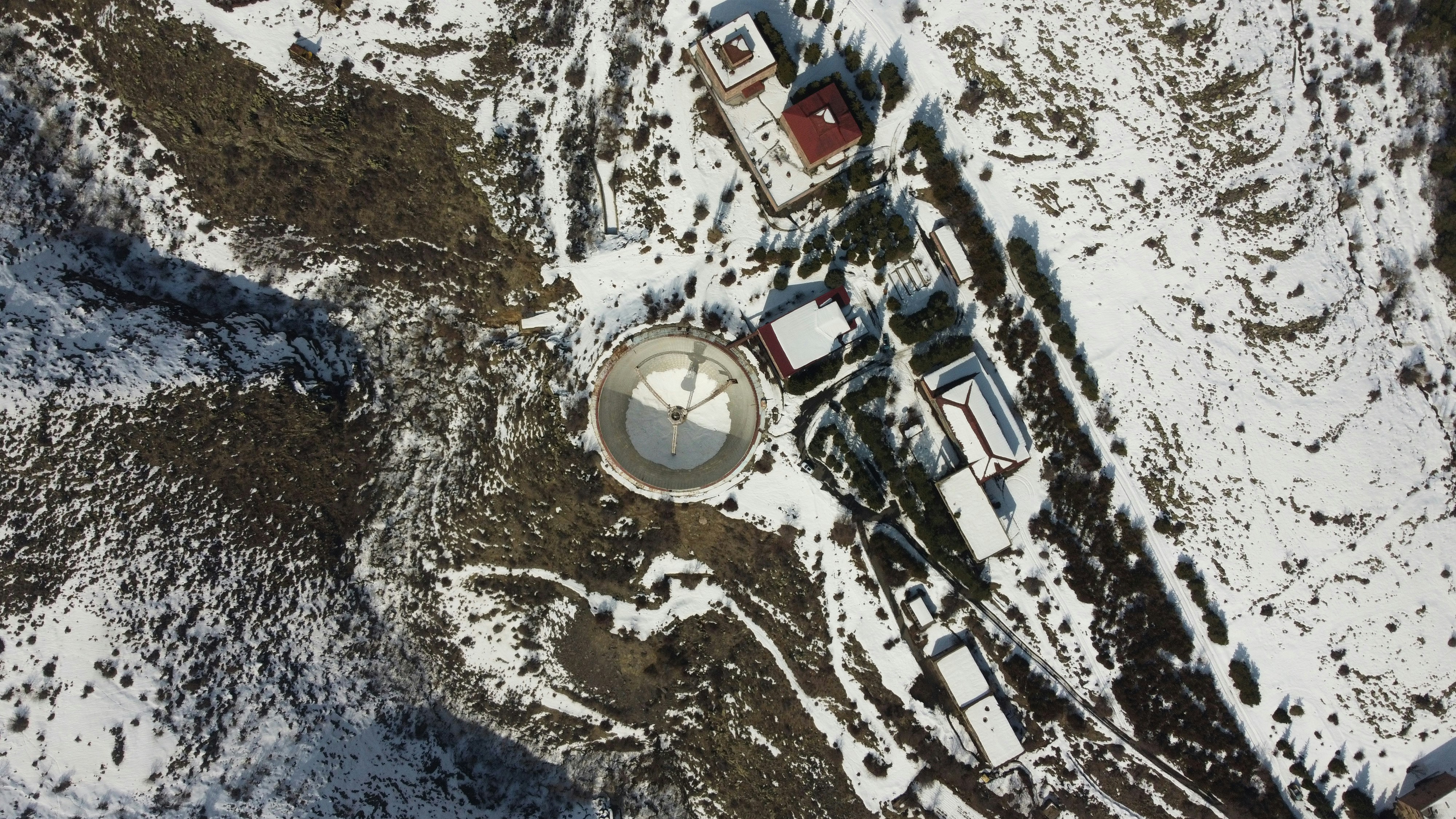 Circular Observatory on Snow-Dusted Ridge