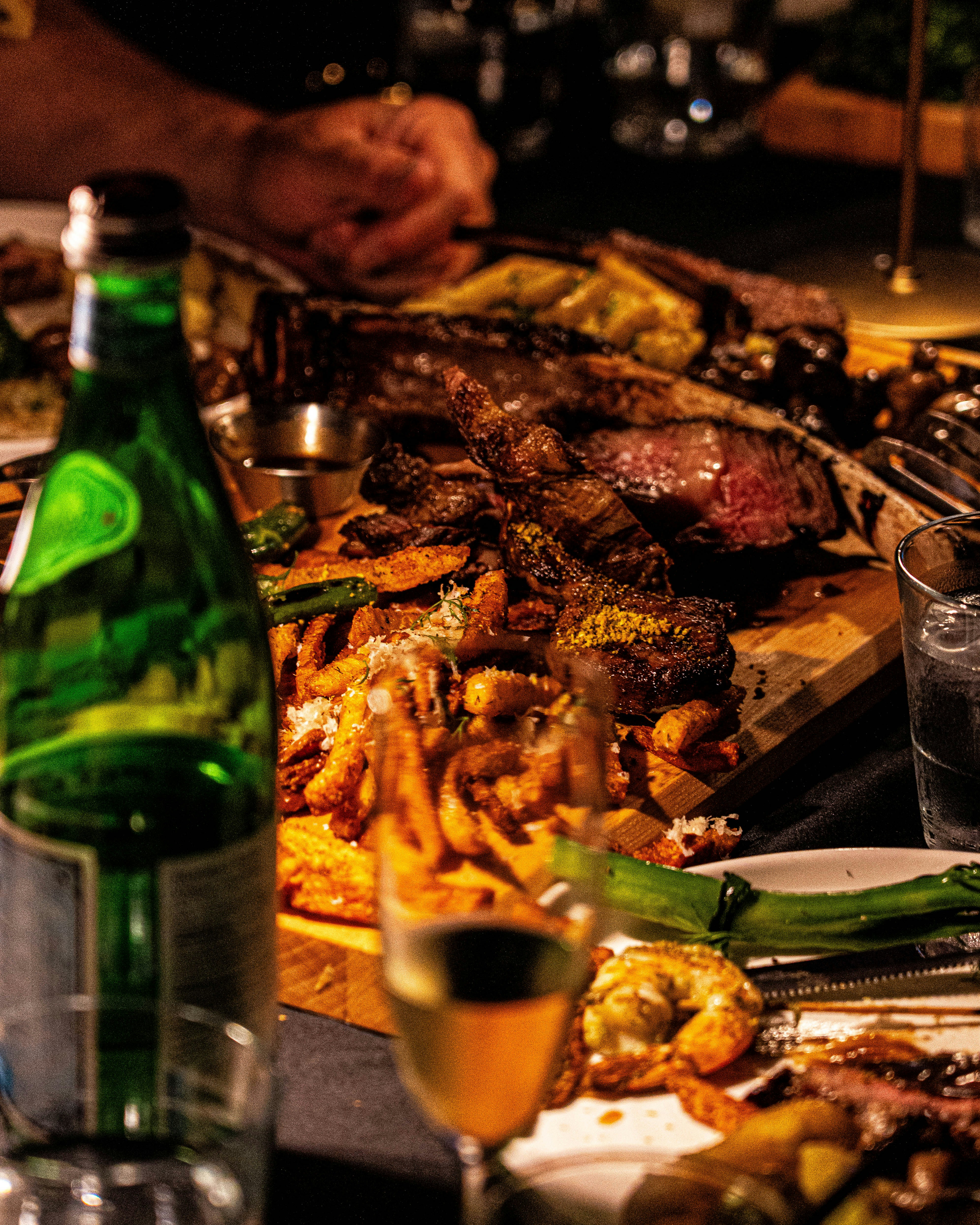 Midnight Feast: A Rustic Board of Steak and Fries Under Ambient Light