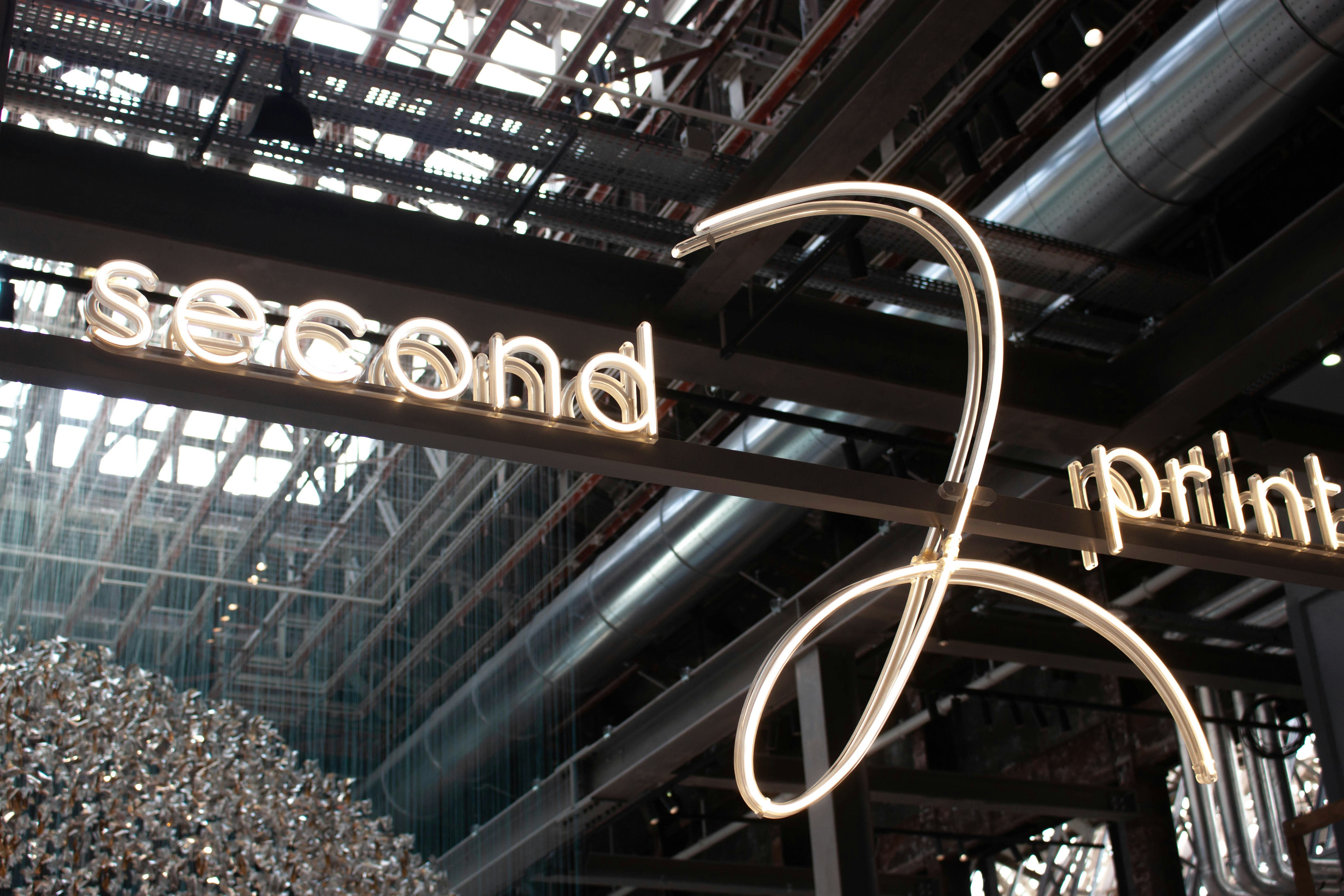 Glowing Script at the Entrance: A Modern Steel Parade