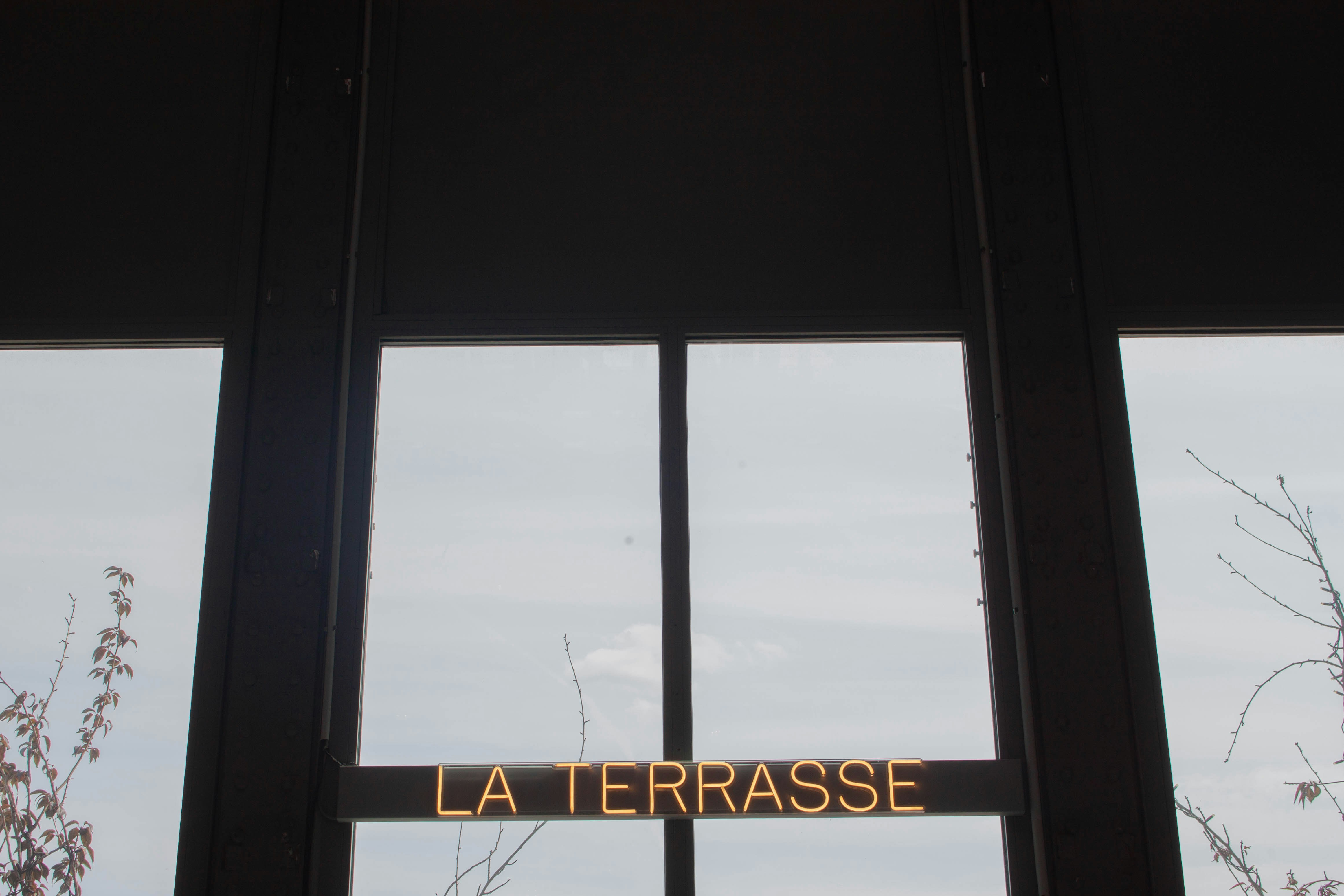Neon Sign at the Edge: LA TERRASSE Framing the Quiet Window