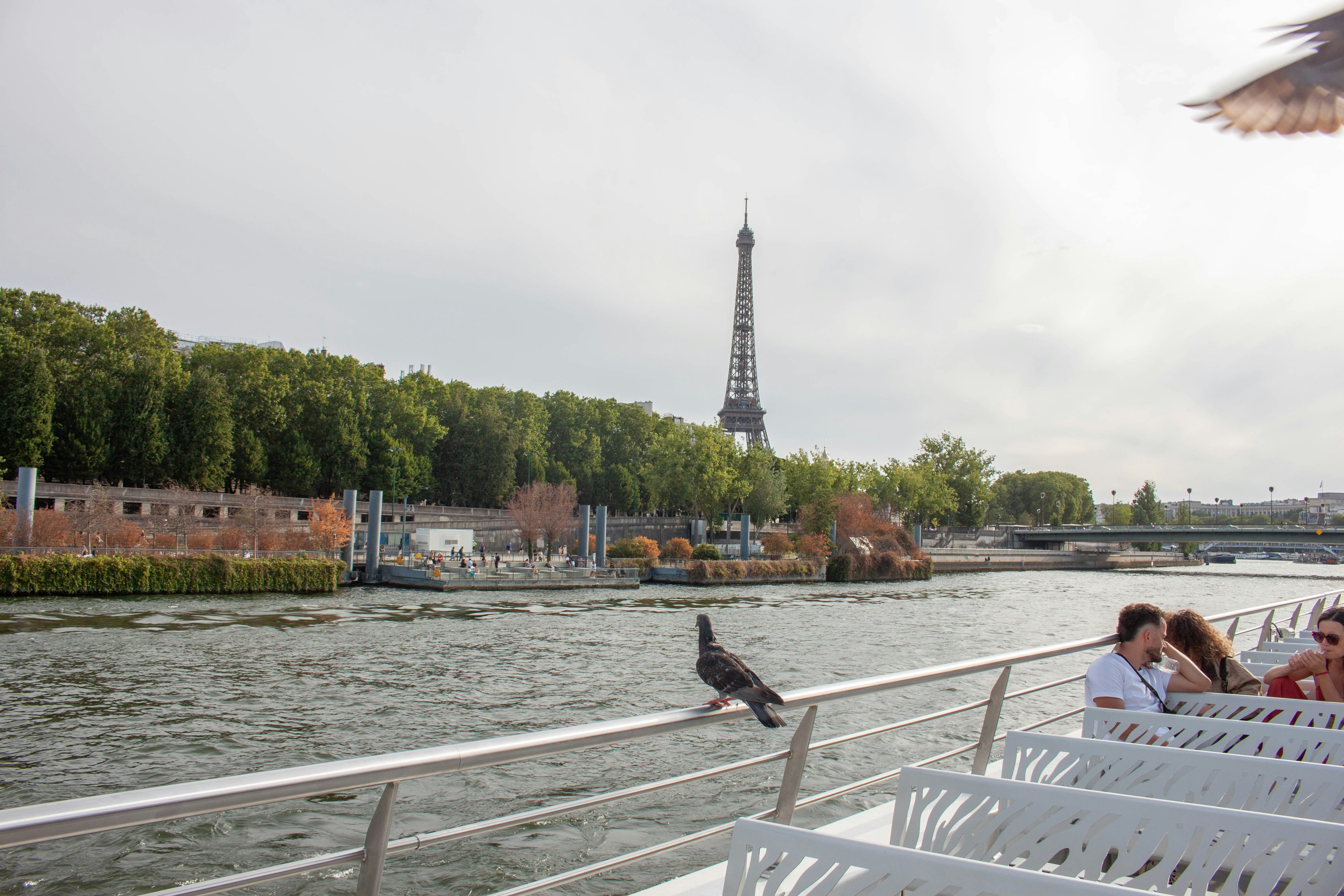 Parisian Riverfront Calm: A Crowded Boat Deck with the Eiffel Tower Aglow