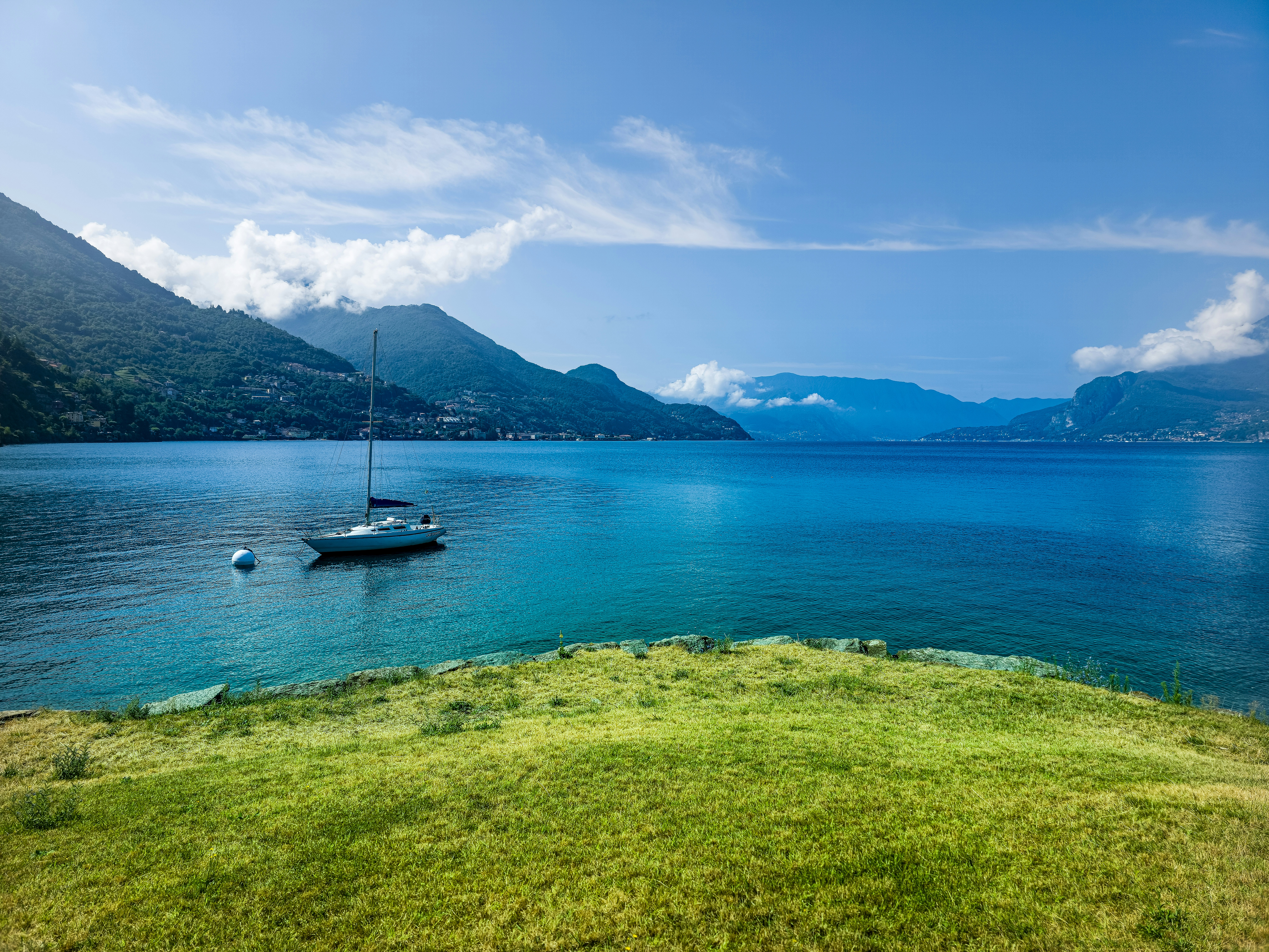 A Quiet Mooring: Sailboat at the Shore of a Mountain-Guarded Lake