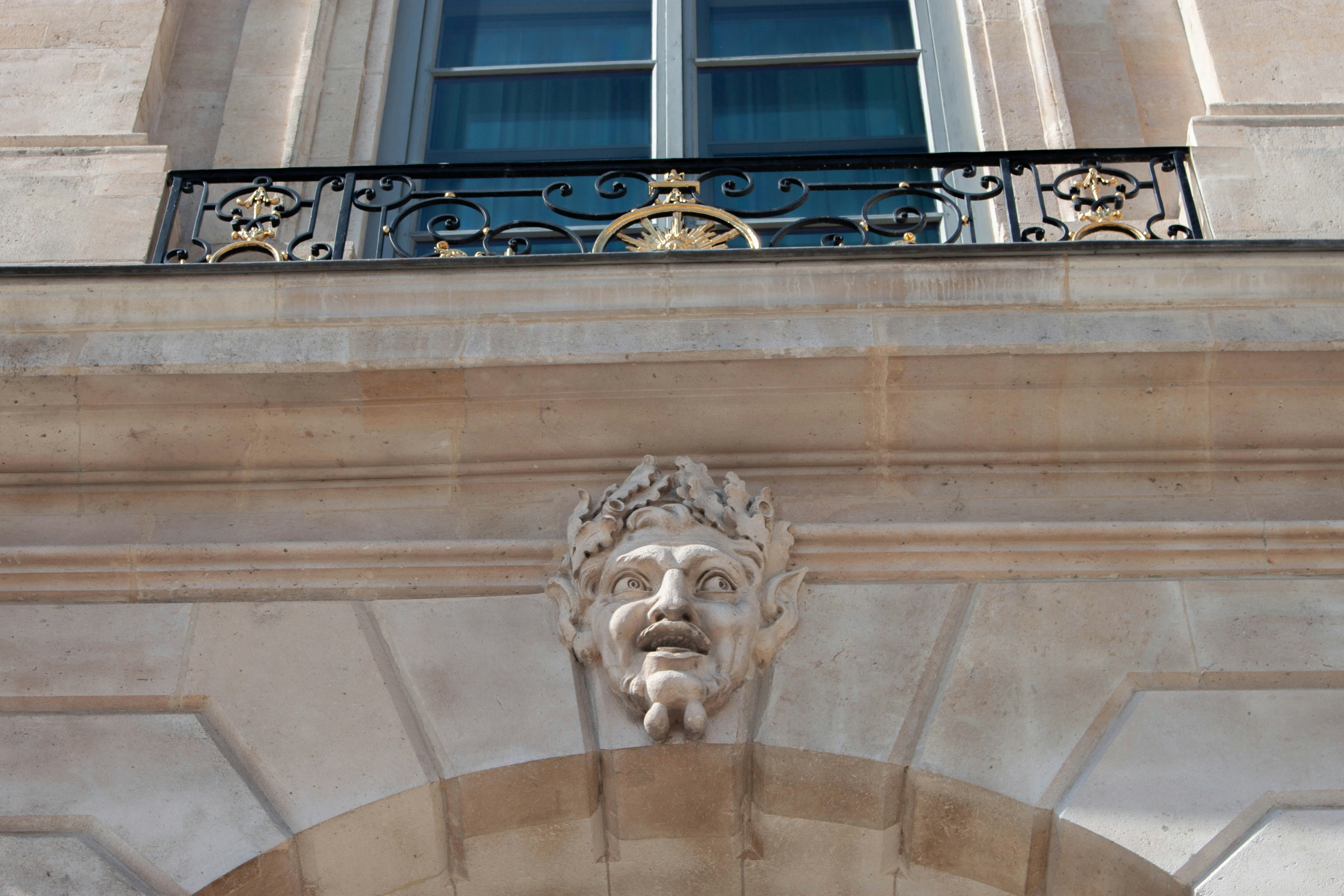 Stone Gorgon Over Arch: A Classical Facade Details Shaped by Light