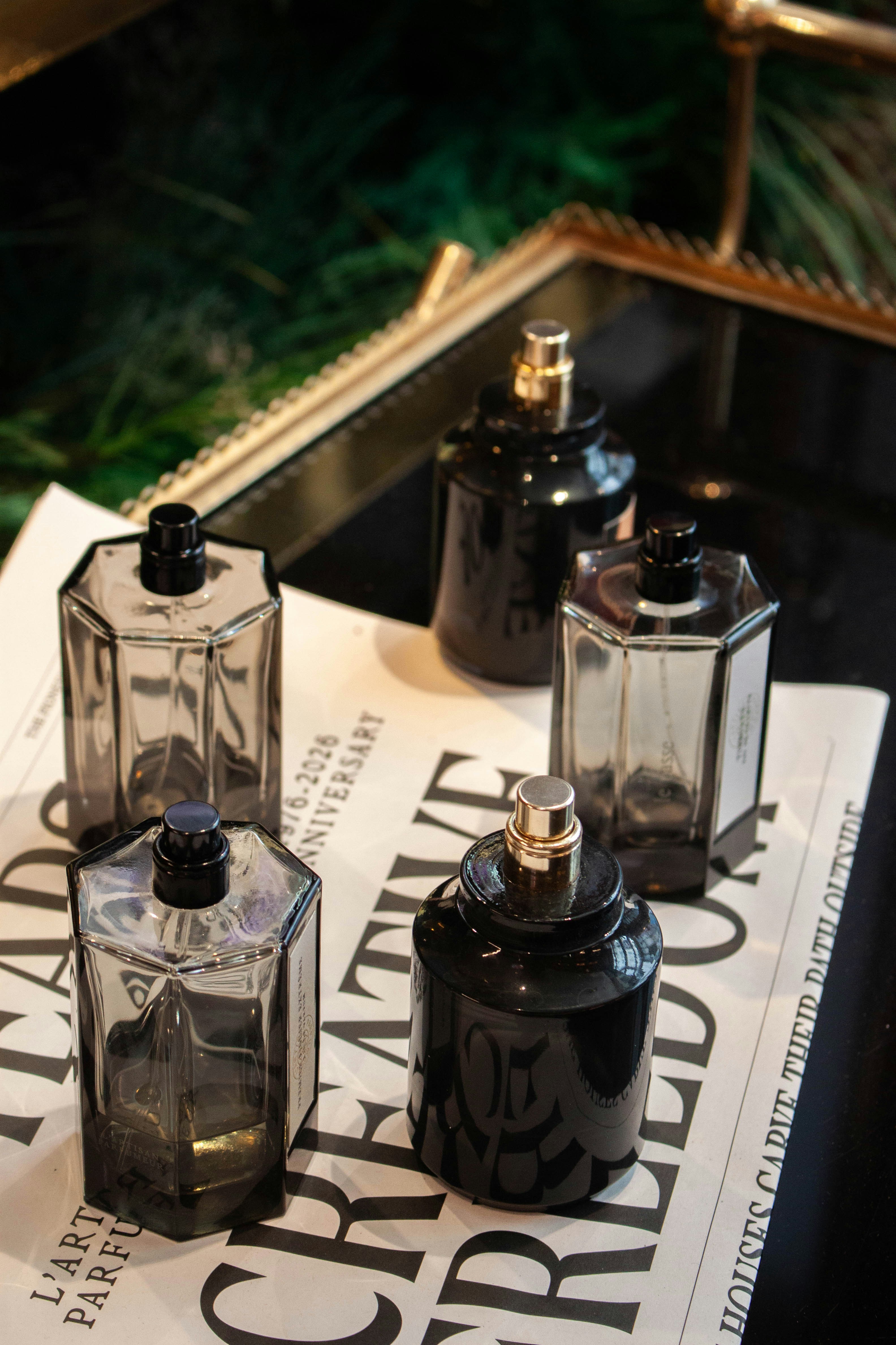 Glass Castles: A Still Life of Perfume Bottles on a Printed Surface