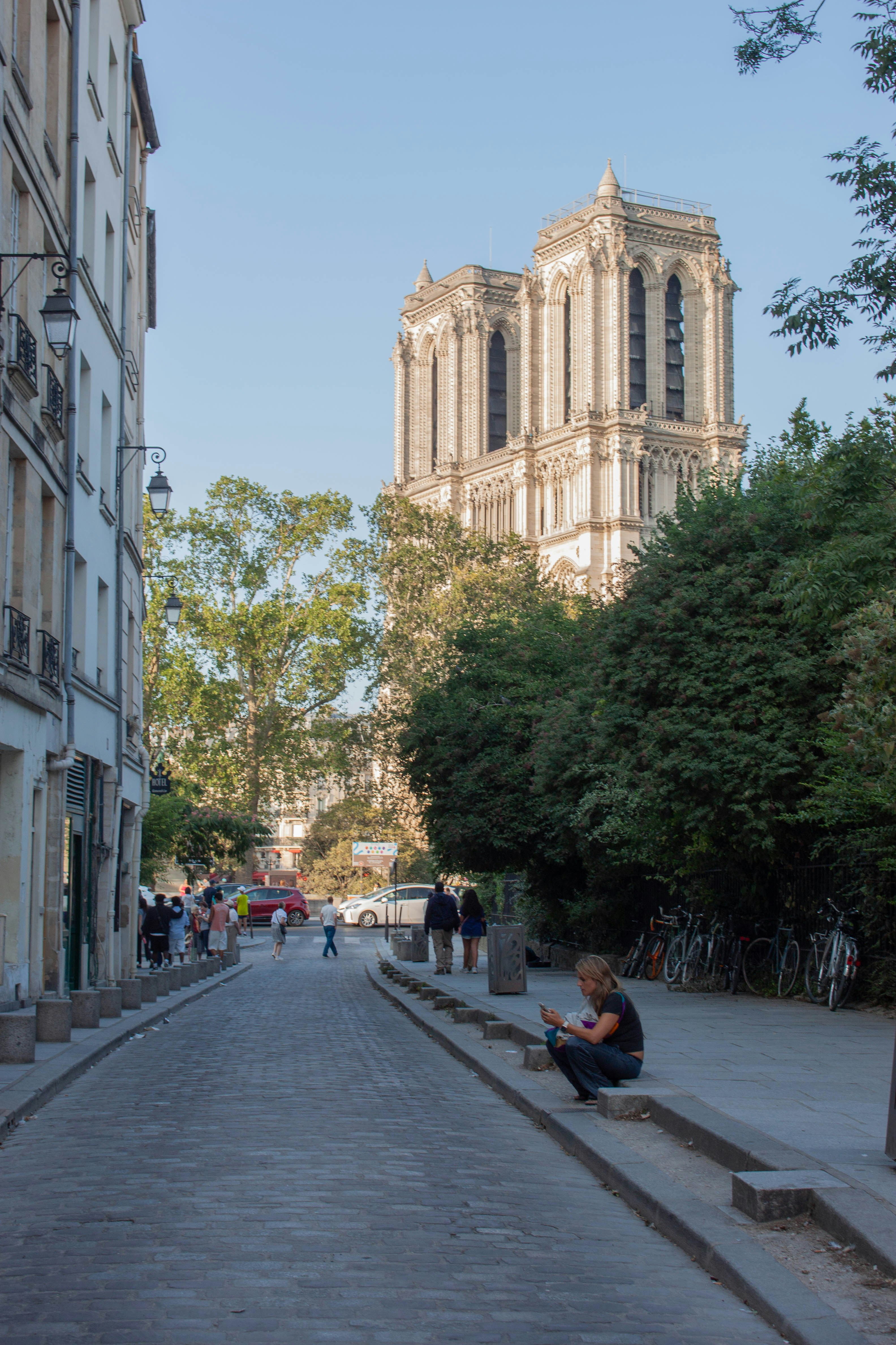 Light on the Alley: Notre Dame Tower Rising Over a Quiet Parisian Street