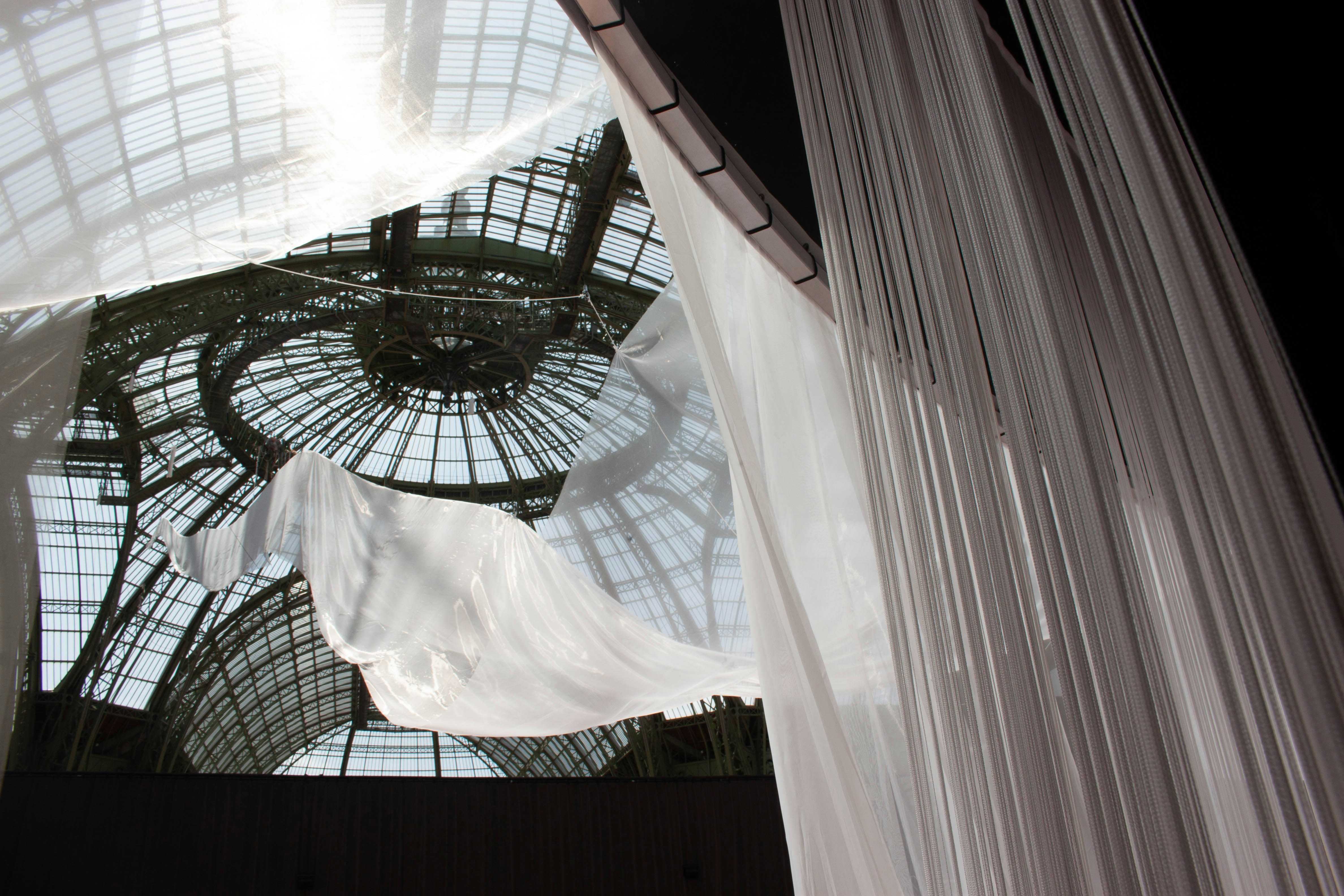 Glass Cathedral: Sunlit Dome and Flowing Drapes in a Modern Atrium