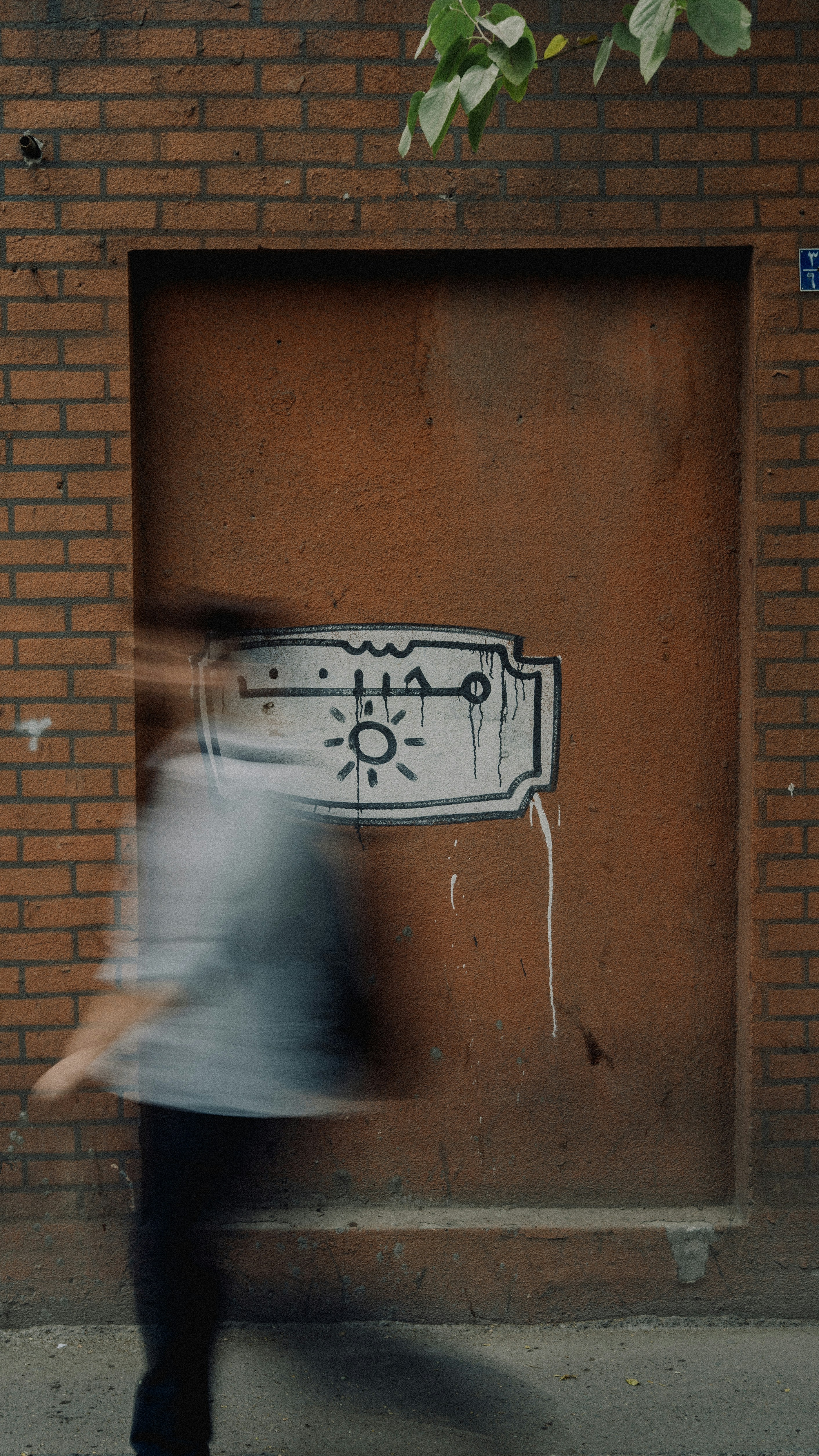 Blurred Wanderer in Front of a Graffiti Panel