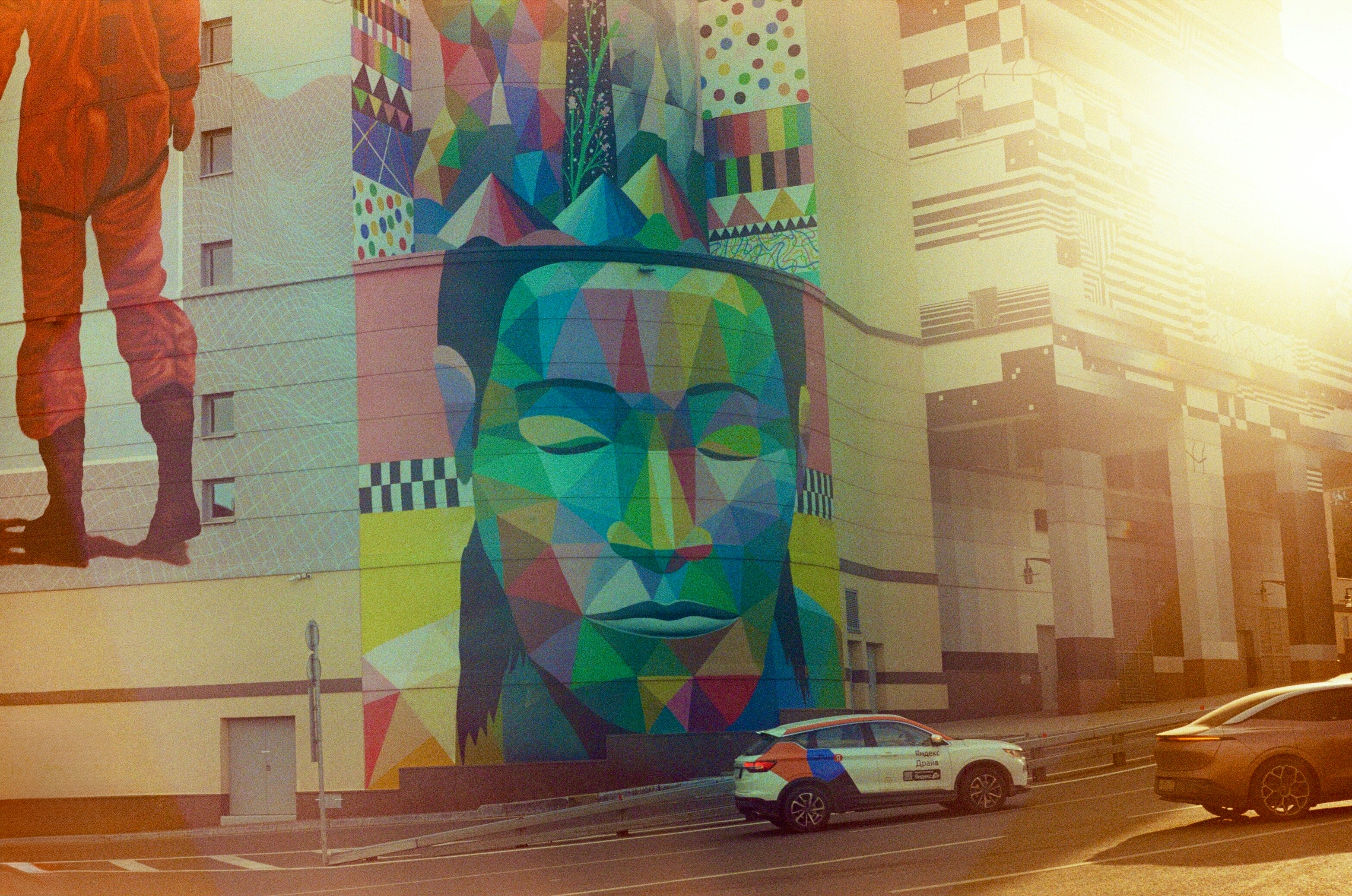 Geometric Mask: A Colorful Portrait on a City Wall