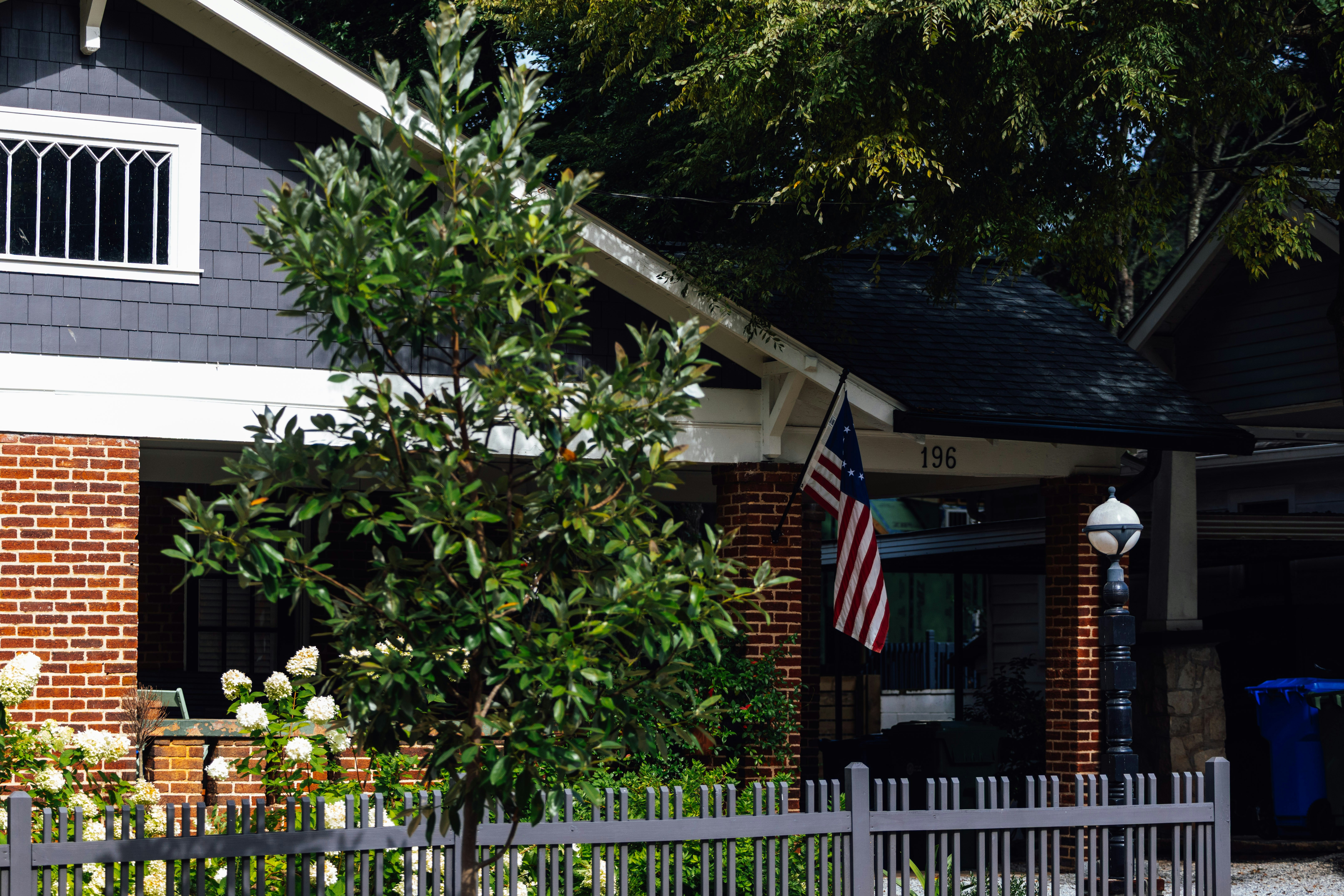 American Suburban Porch: A Quiet Morning with Trees and Flag