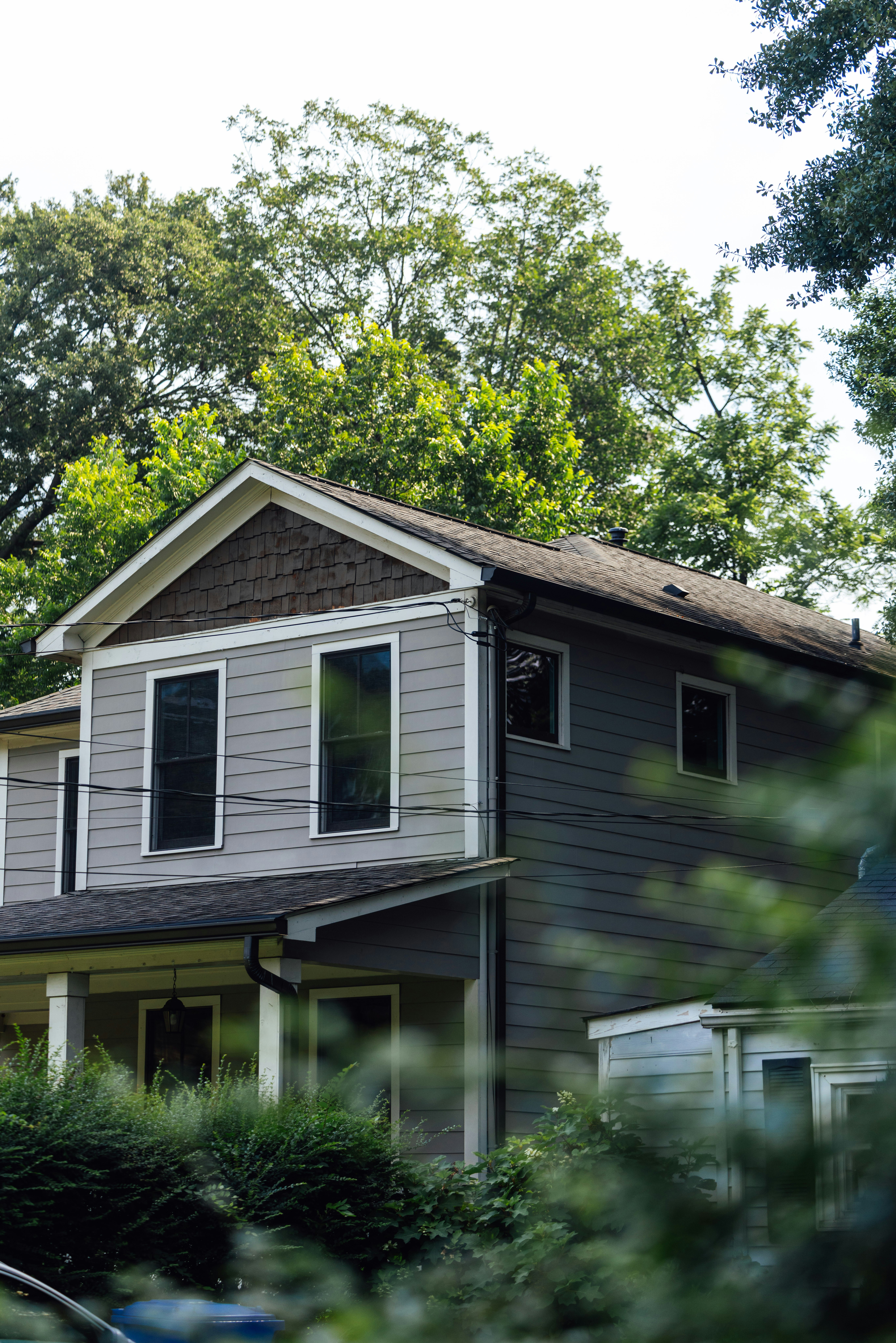 Partially Shaded American Home with Verdant Backdrop